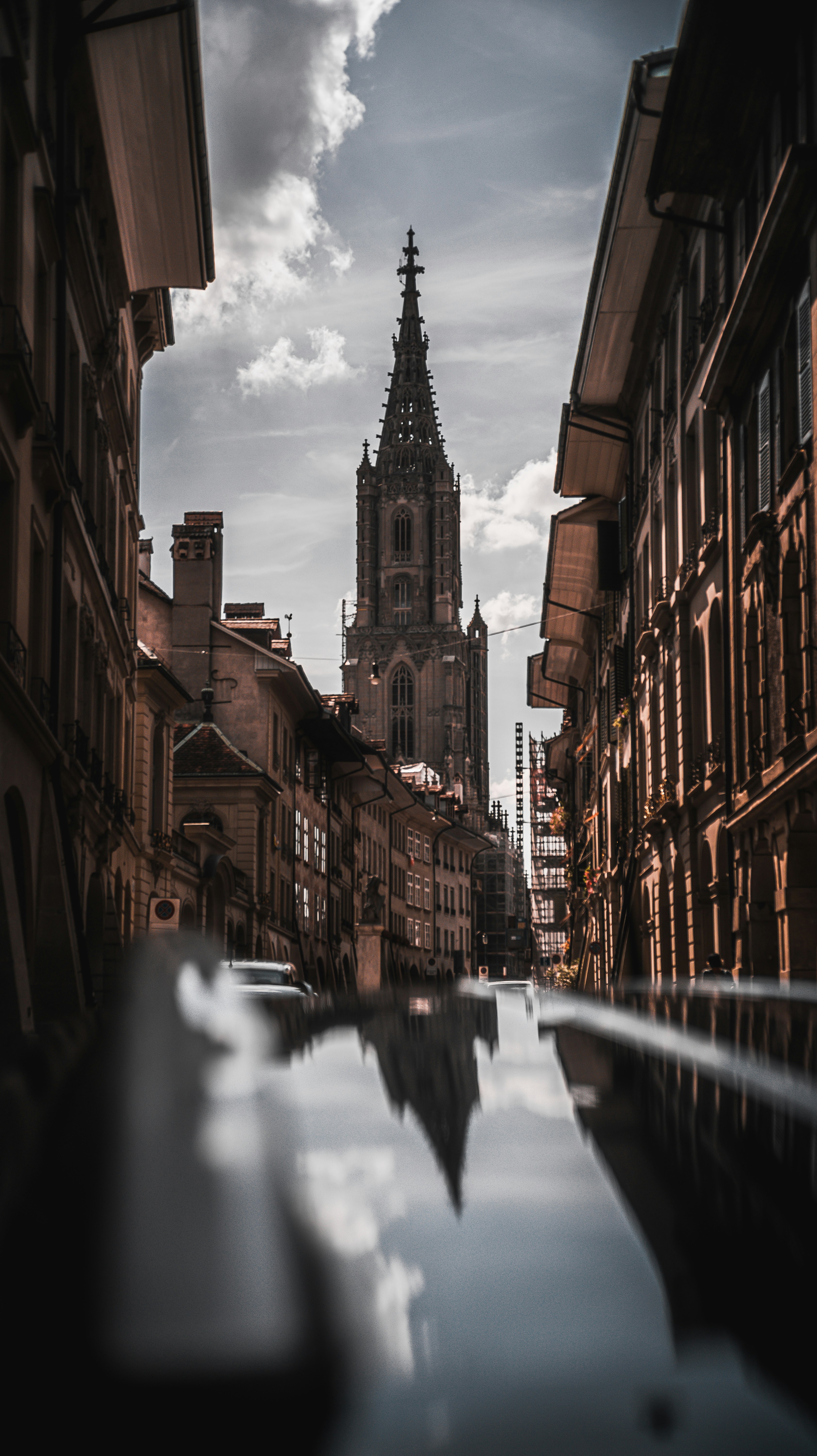 Reflections of Time: A Gothic Spire in Urban Echoes