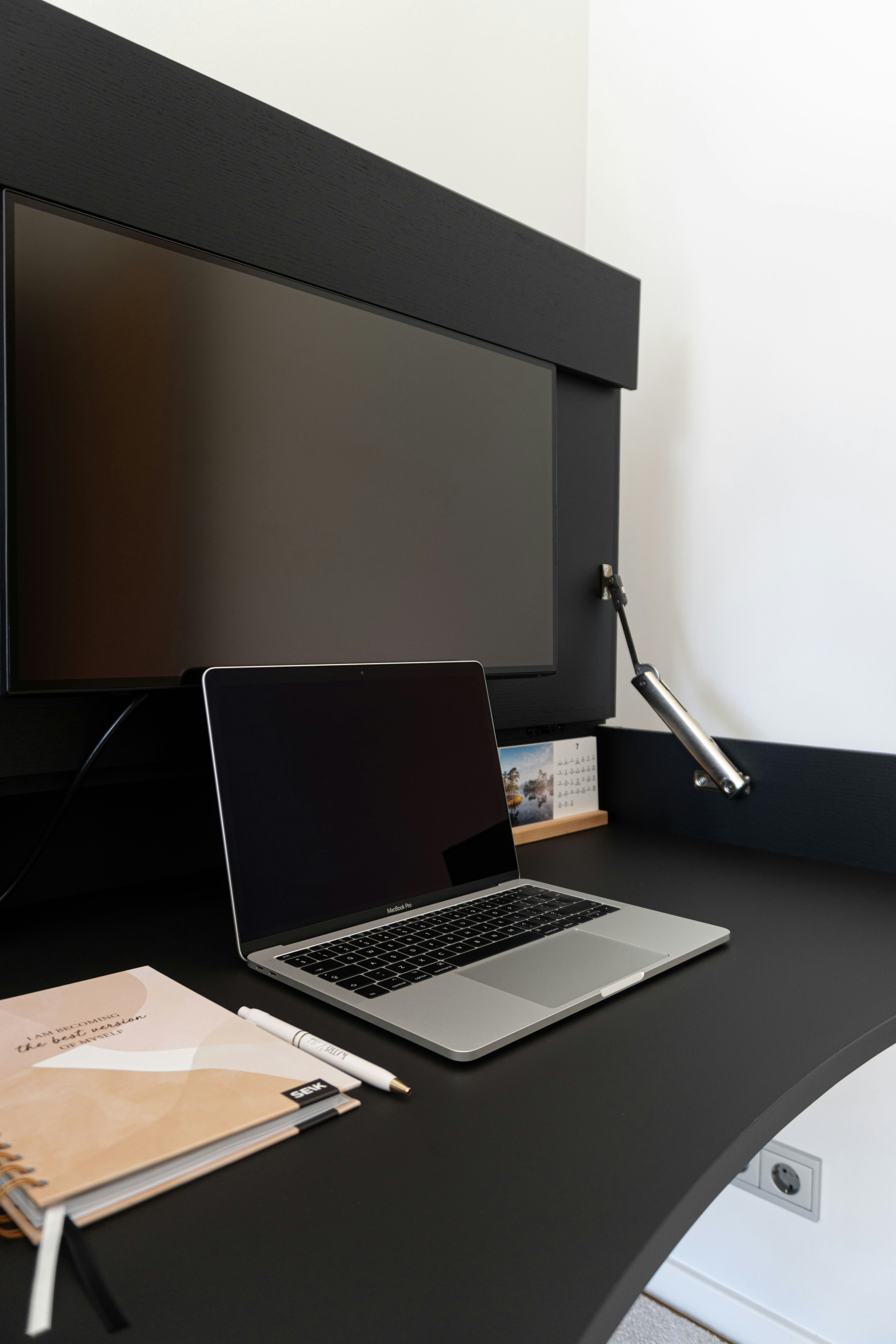 A laptop computer sitting on top of a black desk photo – Free Writing ...