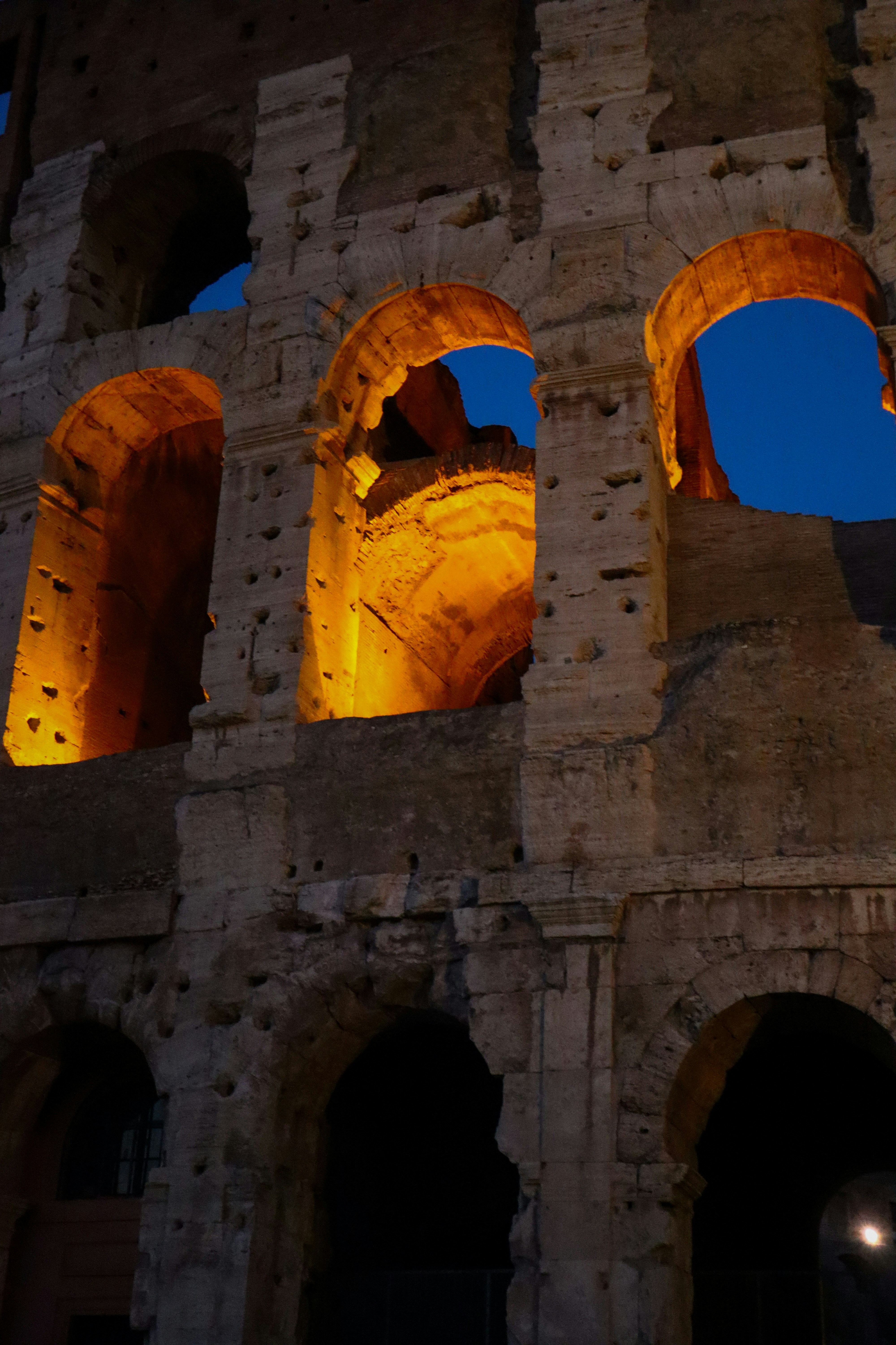 Night Glow through Roman Arches: Amber Light on a Colosseum Facade