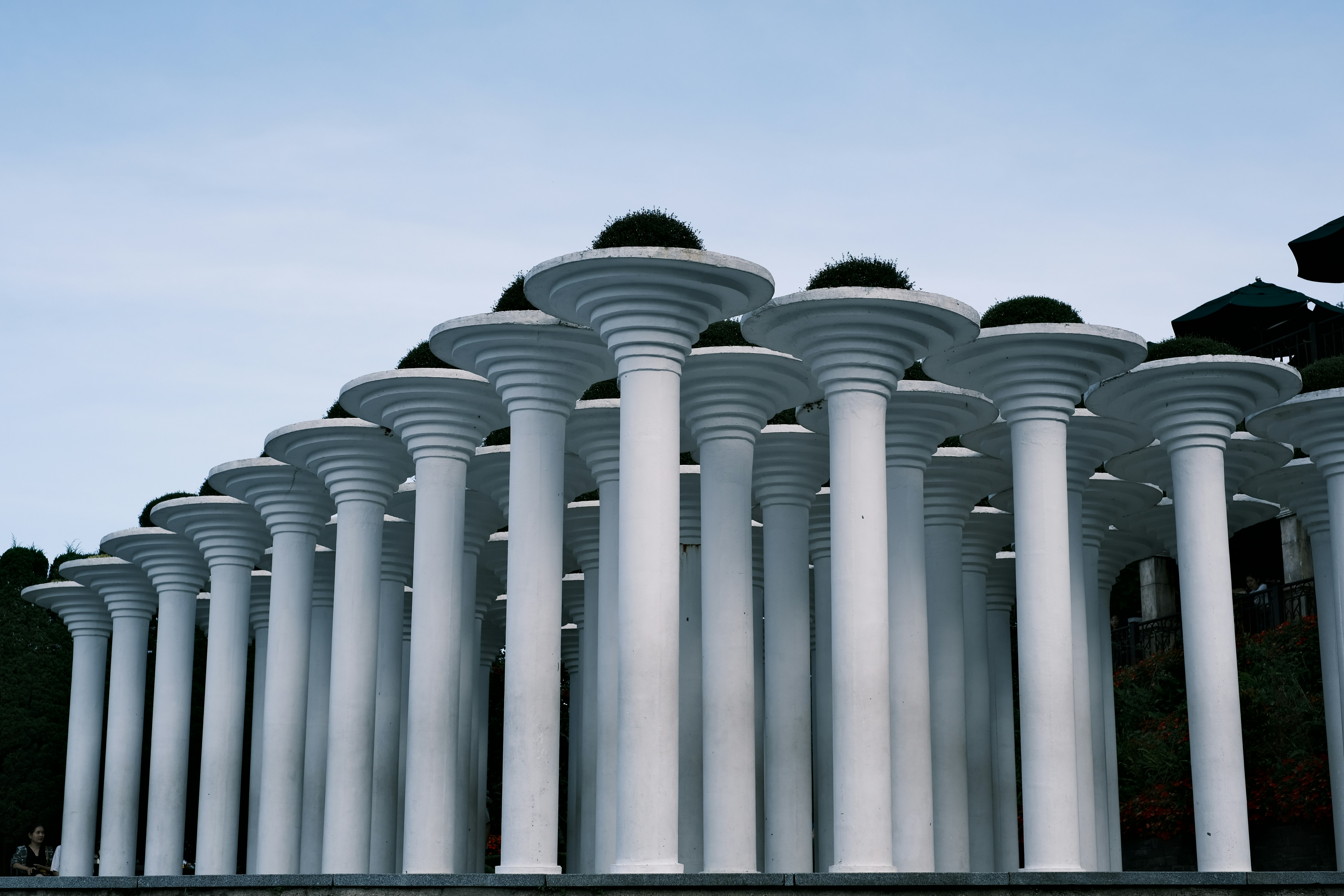 A row of white pillars sitting next to each other photo – Free Building ...