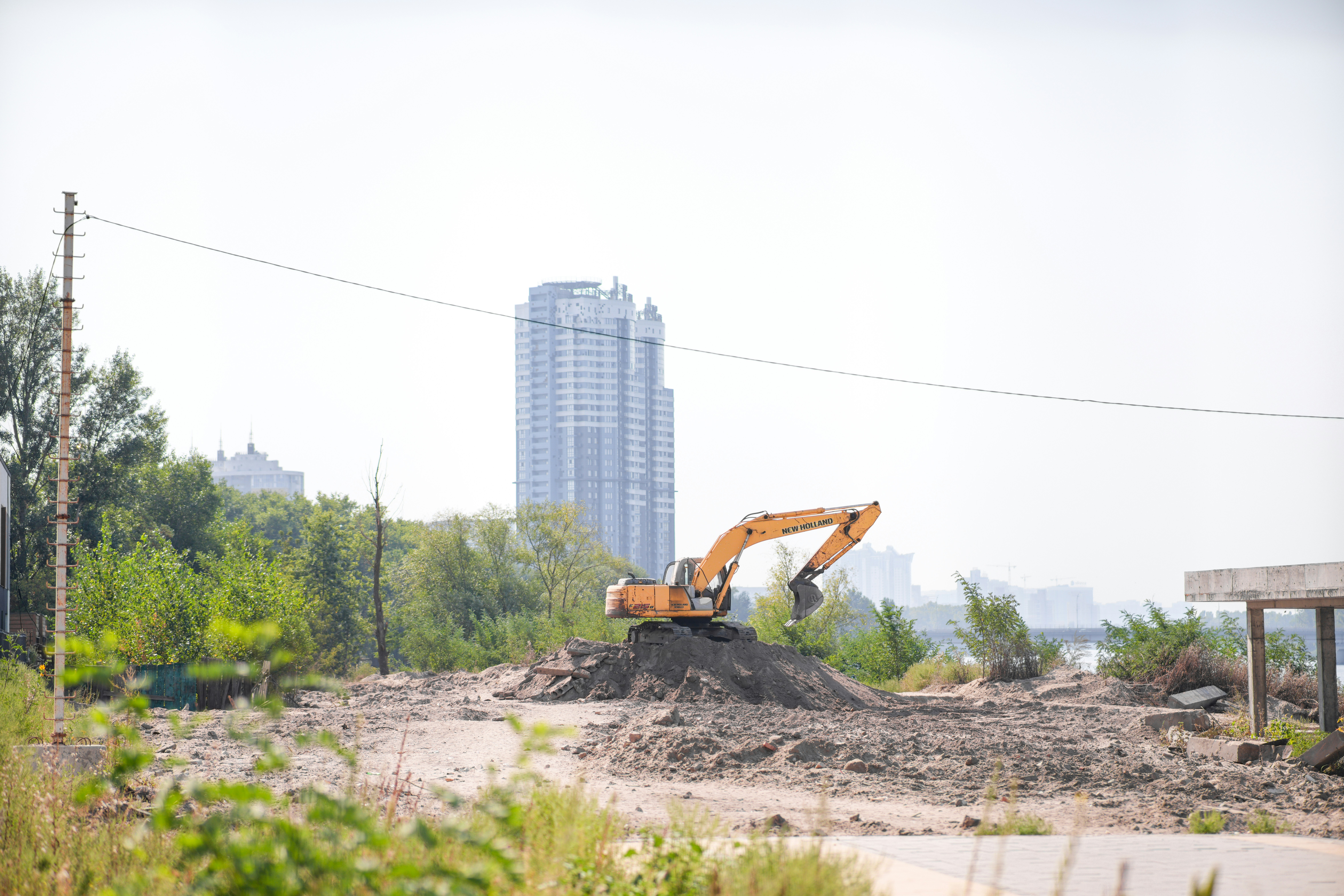King of the hill. High-rise in the background is damaged by debris of something that sometimes flies over Kyiv. But the construction continues.