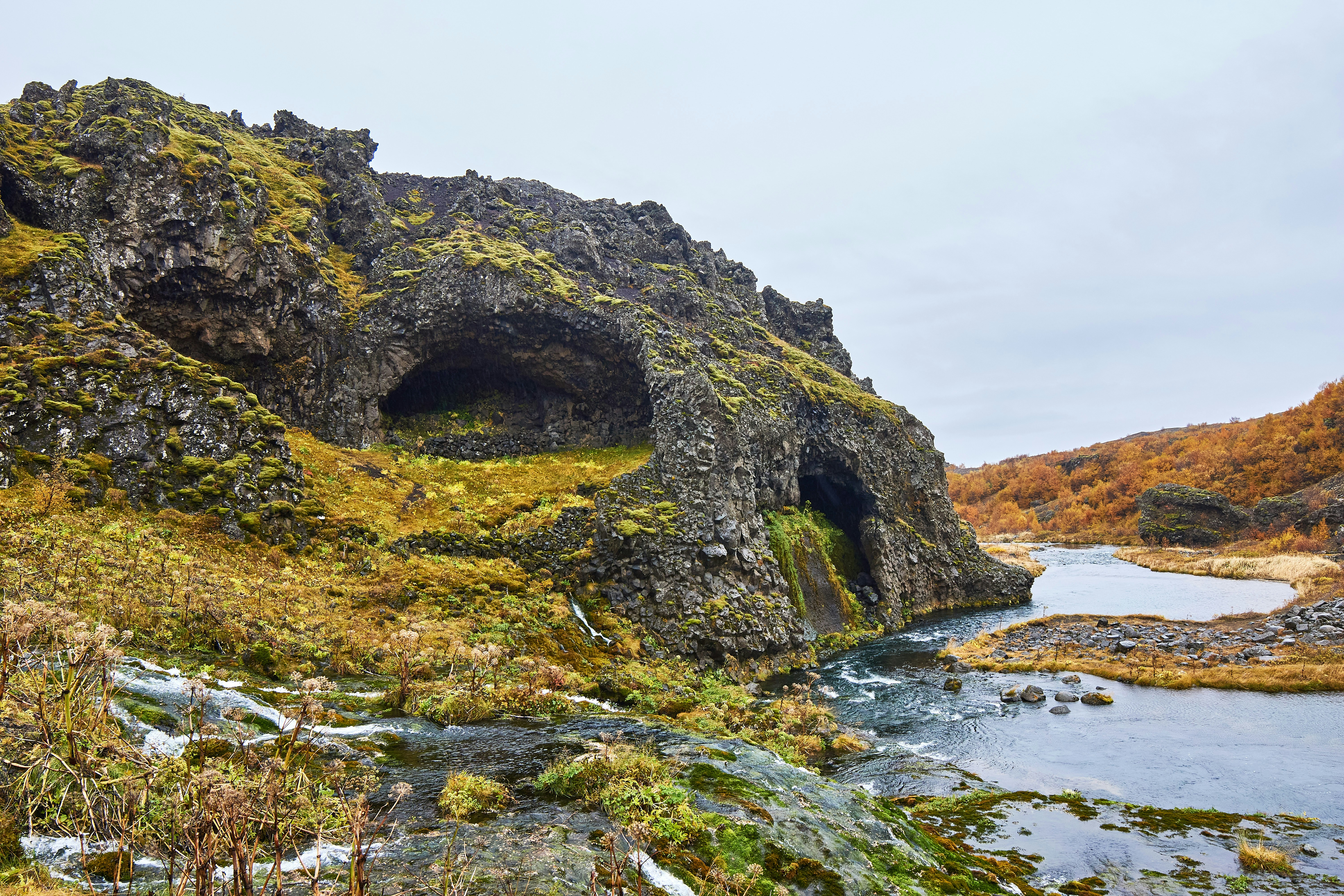 A rocky outcropping with a river running through it photo – Free Rock ...