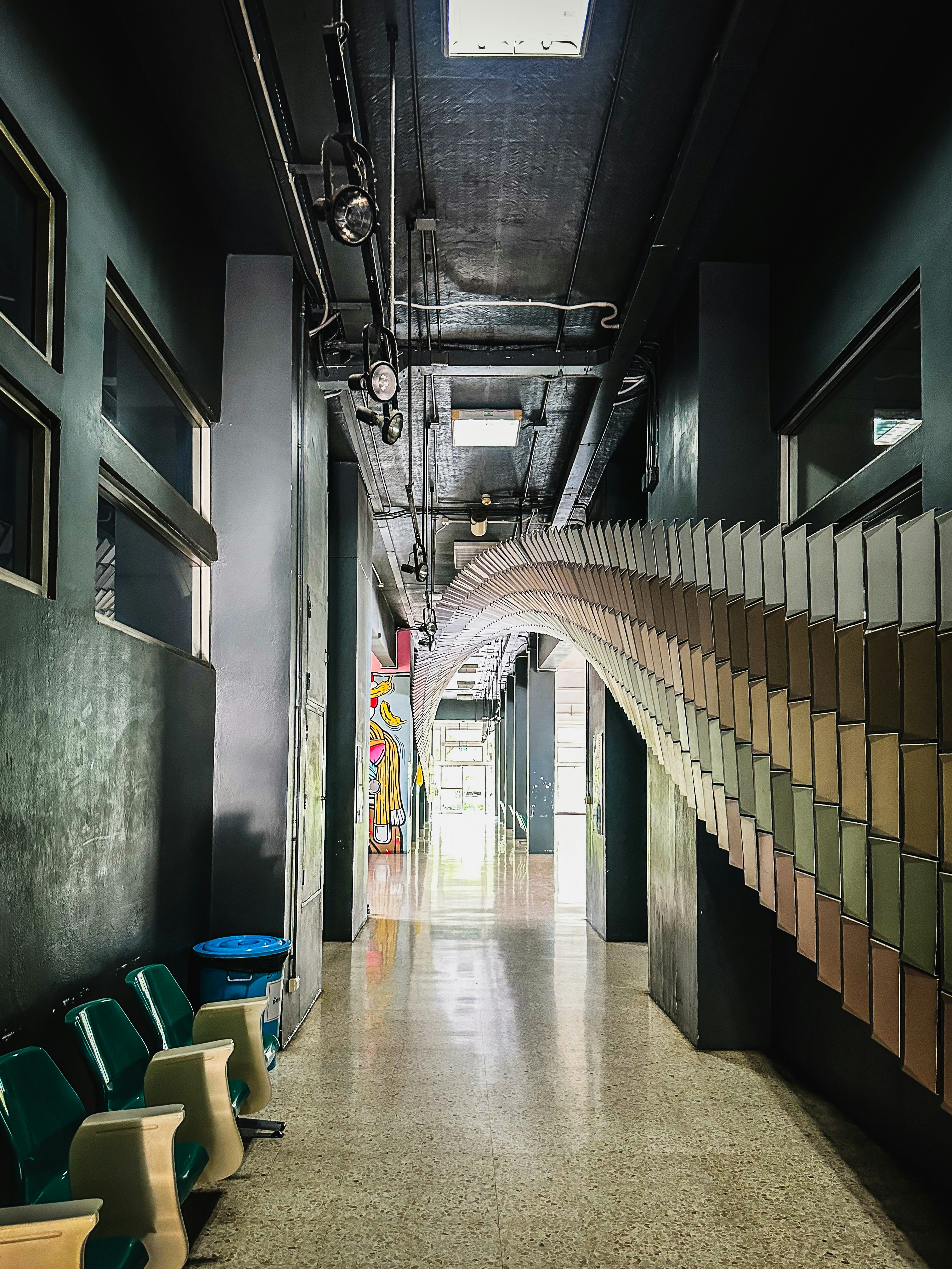 Curved Staircase Corridor Toward a Bright Exit
