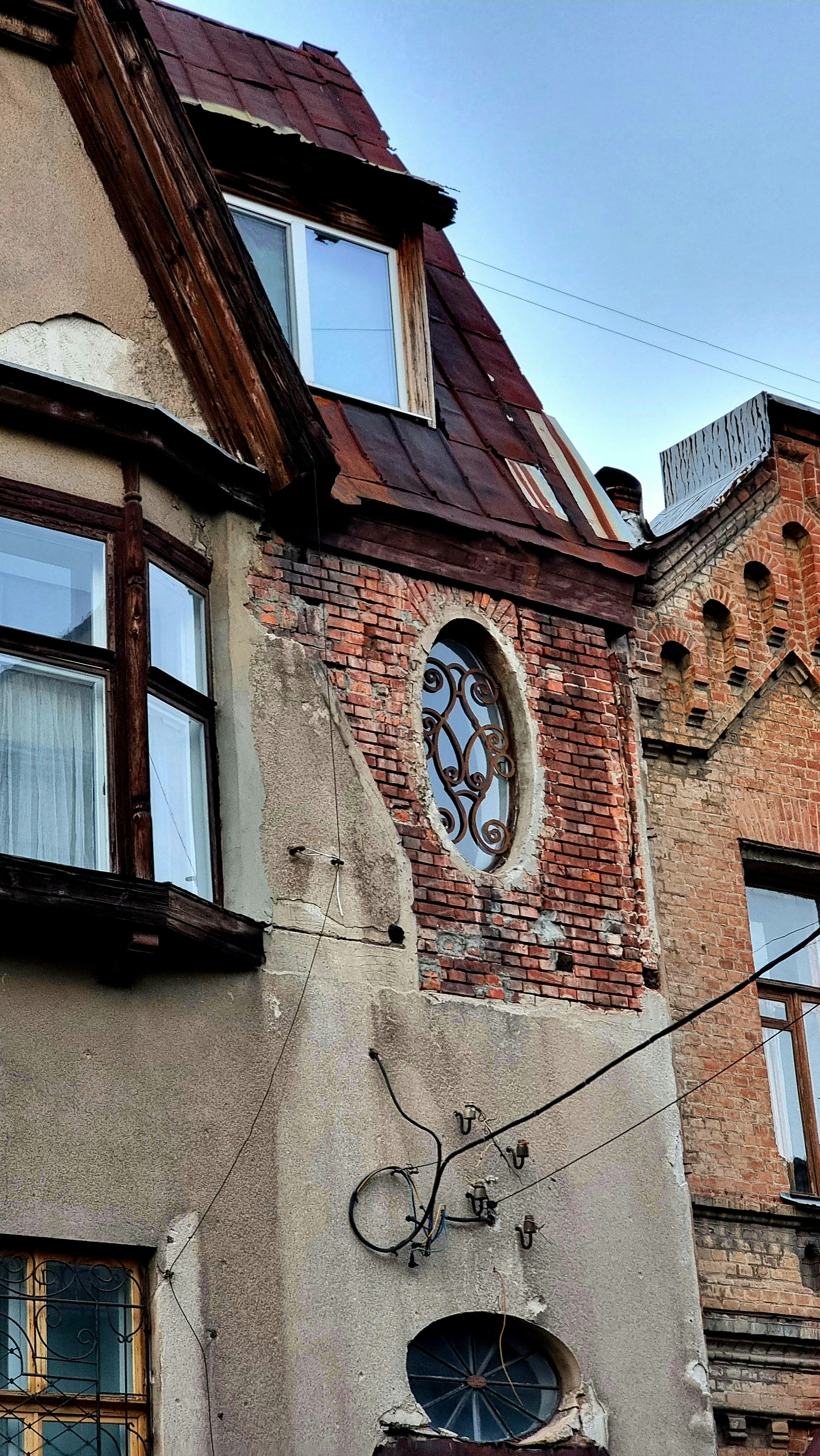 Timeworn Brickwork and a Wrought-Iron Oval Window