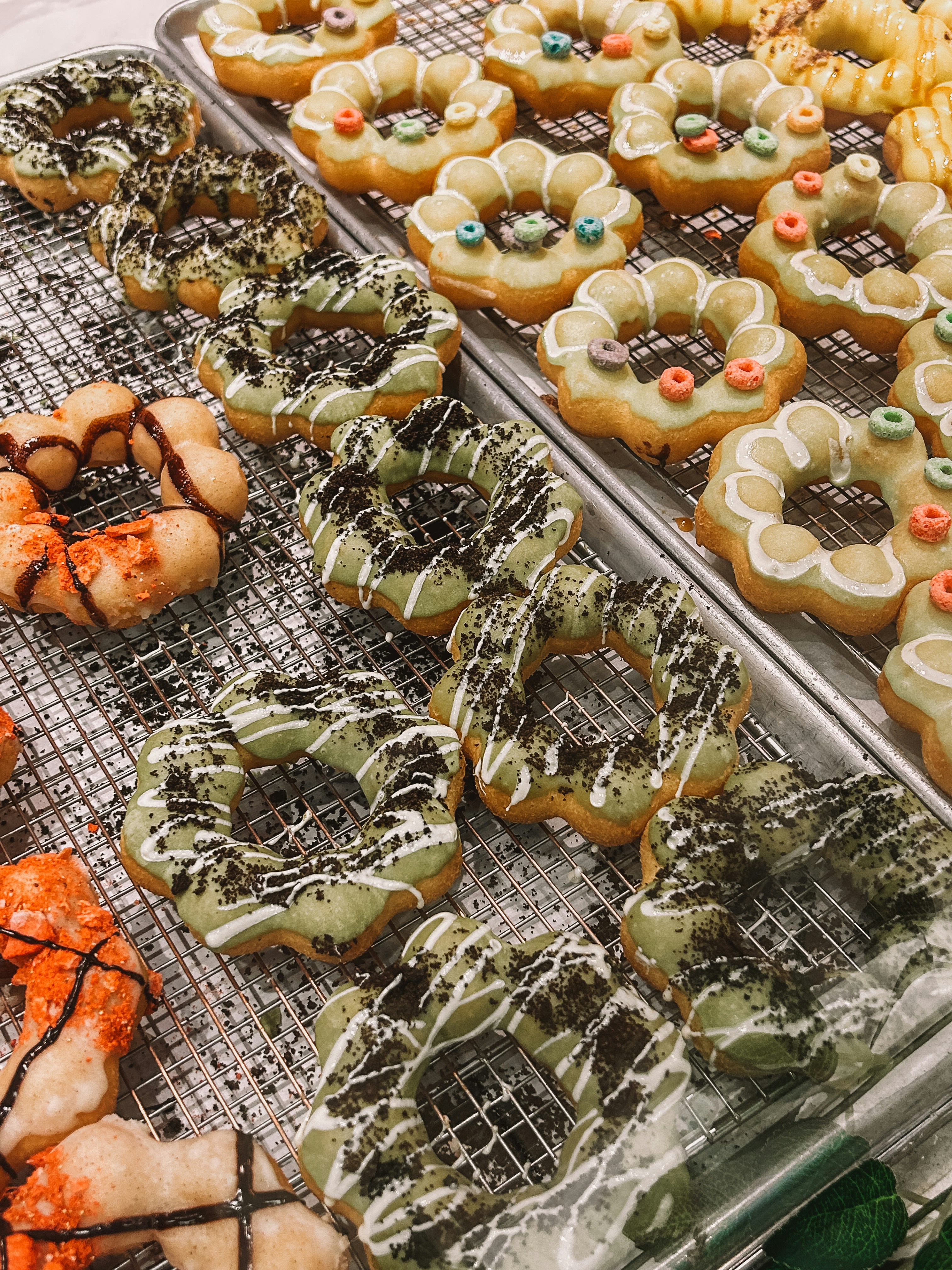 A bunch of doughnuts that are on a rack
