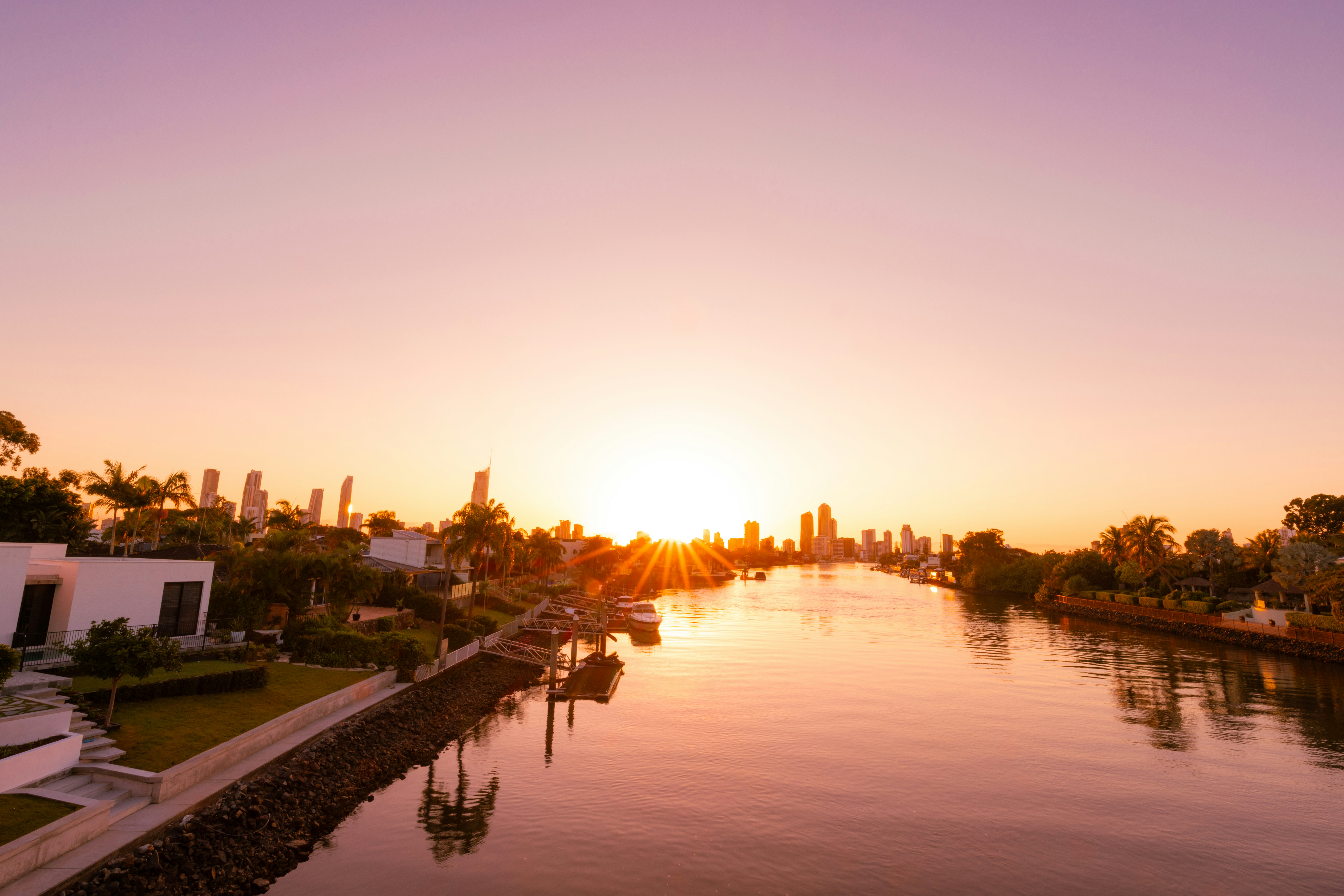 The sun is setting over a body of water photo – Free Surfers paradise ...