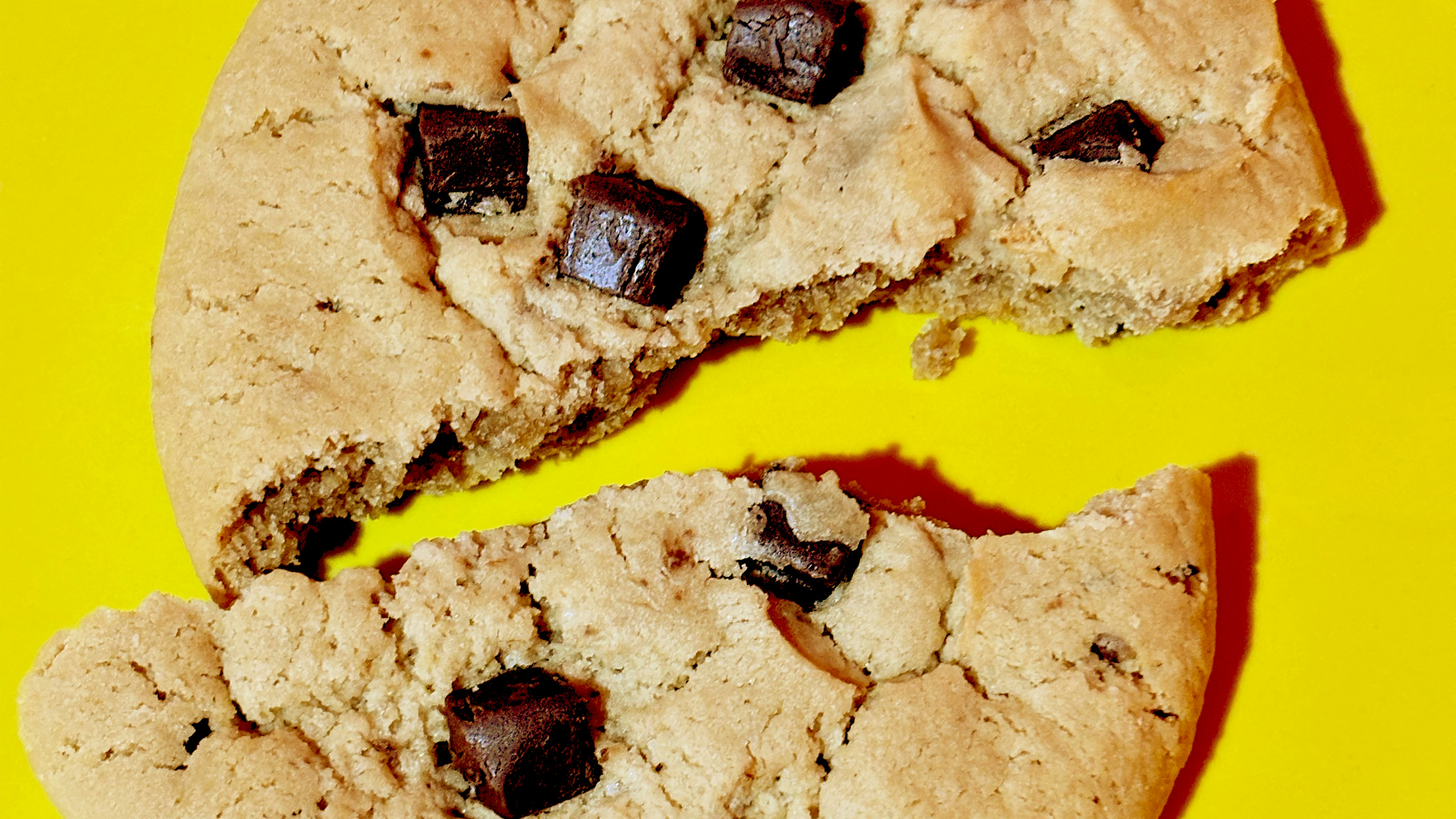 A half eaten chocolate chip cookie on a yellow background photo – Free ...
