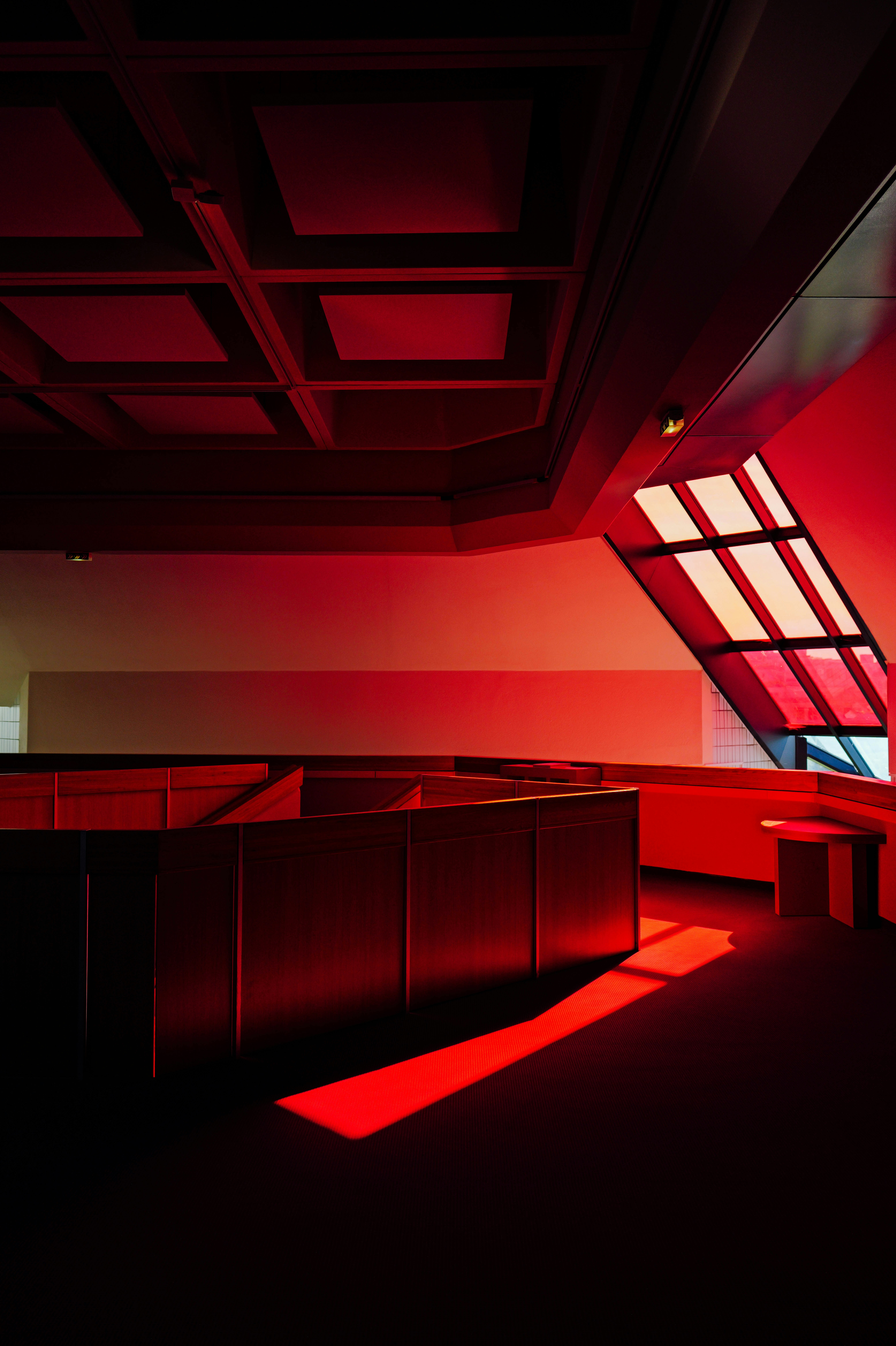 A room with a red light coming through the windows photo – Free ...