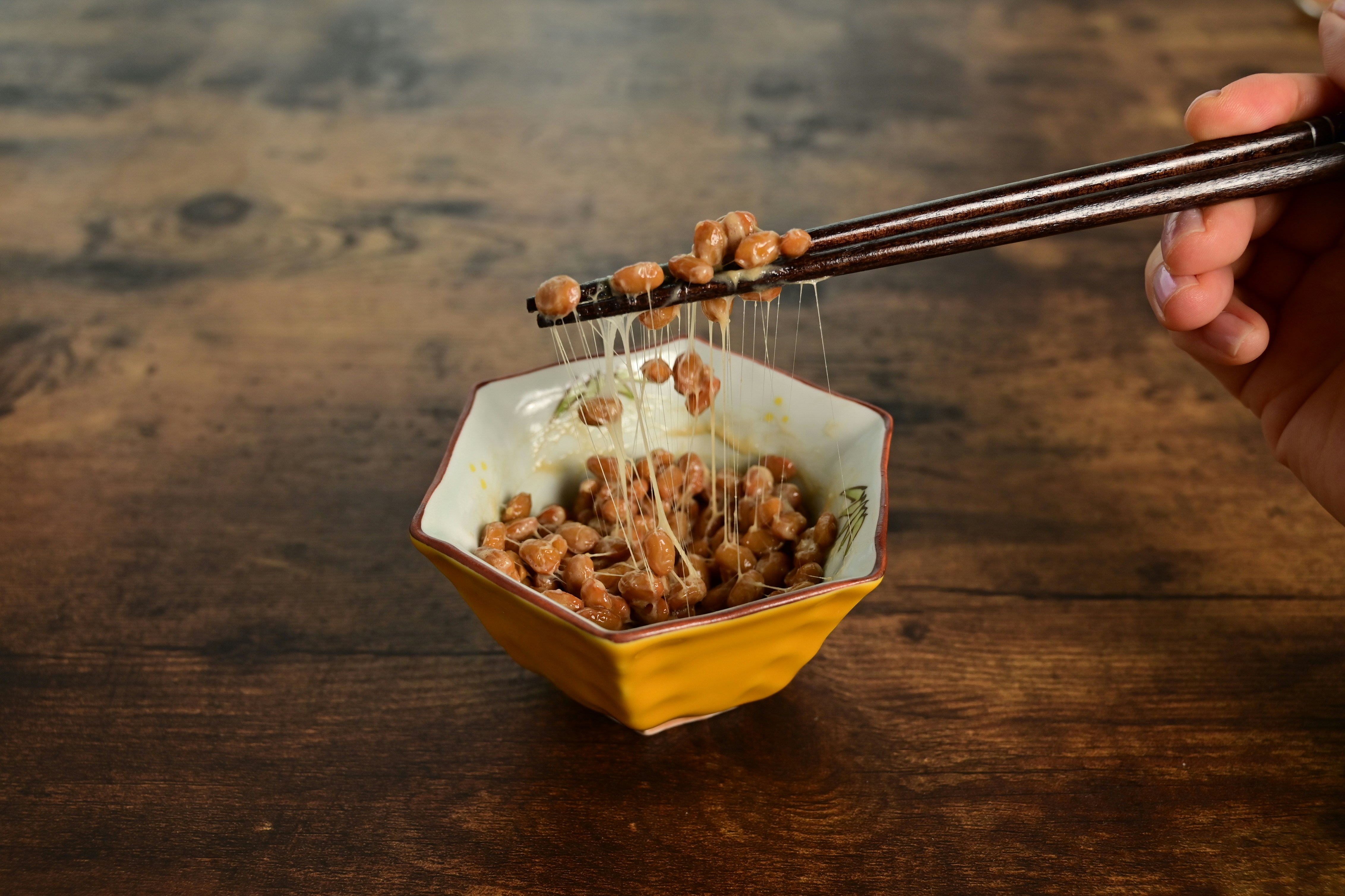 Nut Threads: Chopsticks Lift Crunch from a Sunny Yellow Bowl
