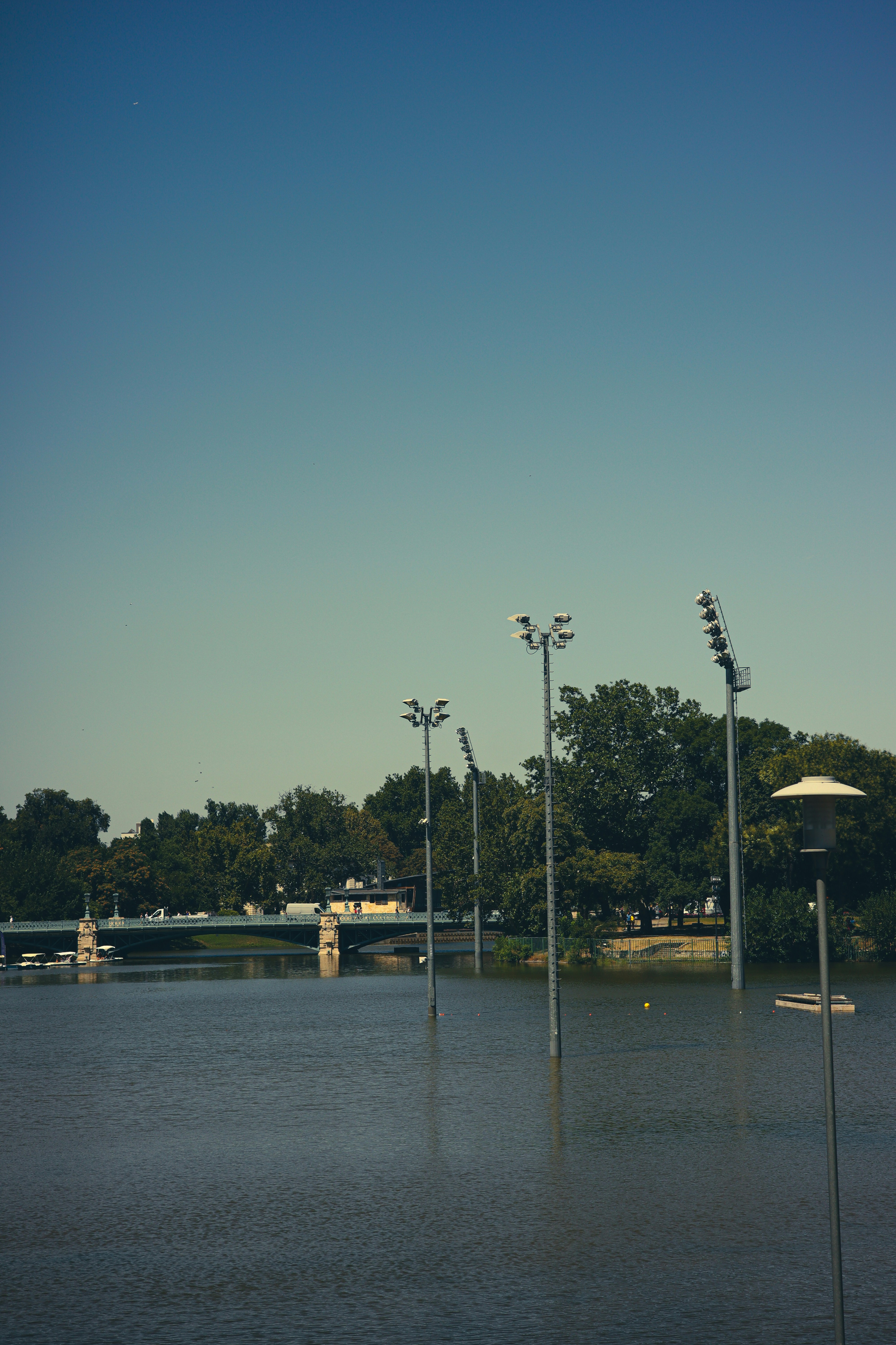 Submerged Beacons and a Serene Riverside Under a Clear Sky