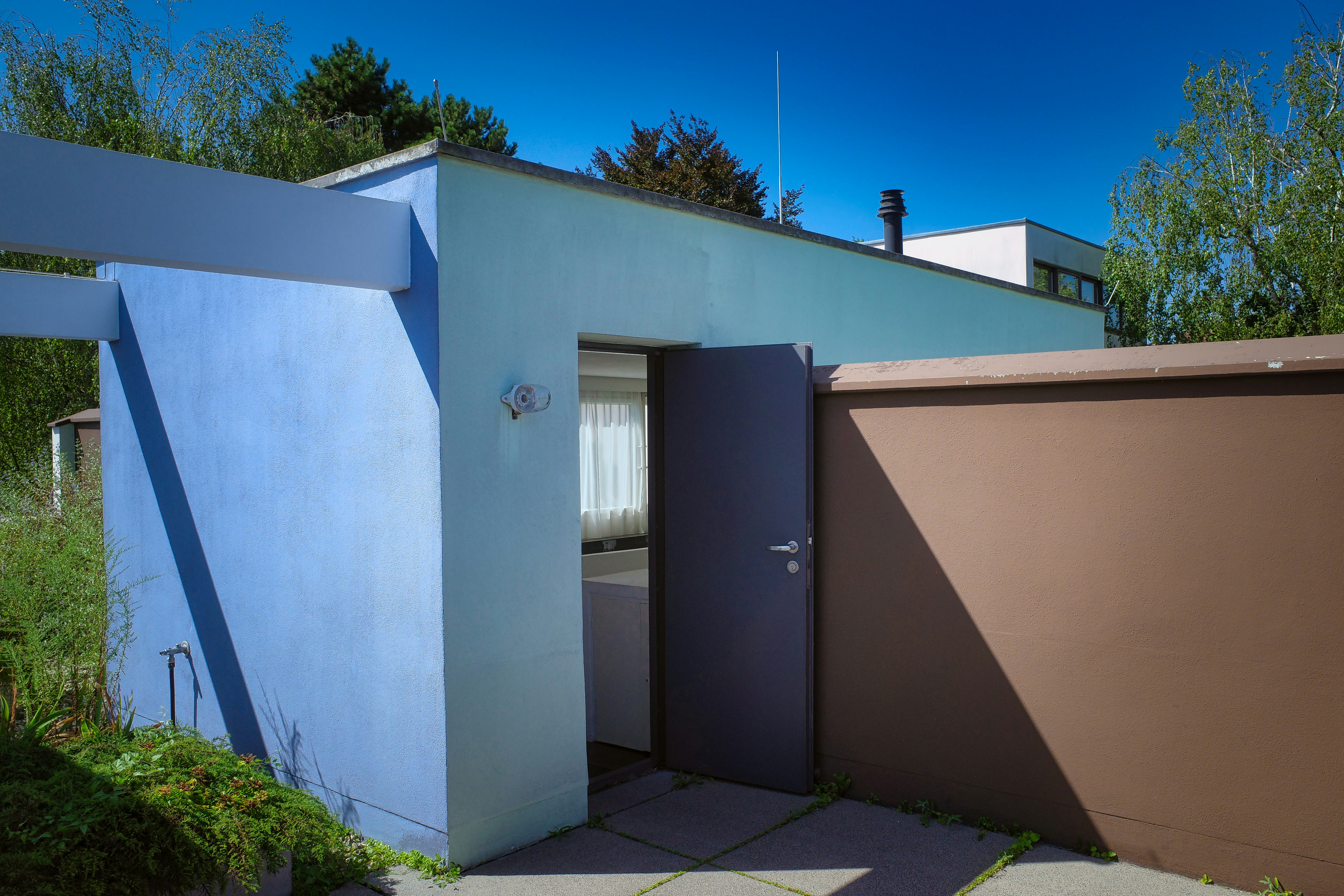 A small blue building with a brown door photo – Free Stuttgart Image on ...