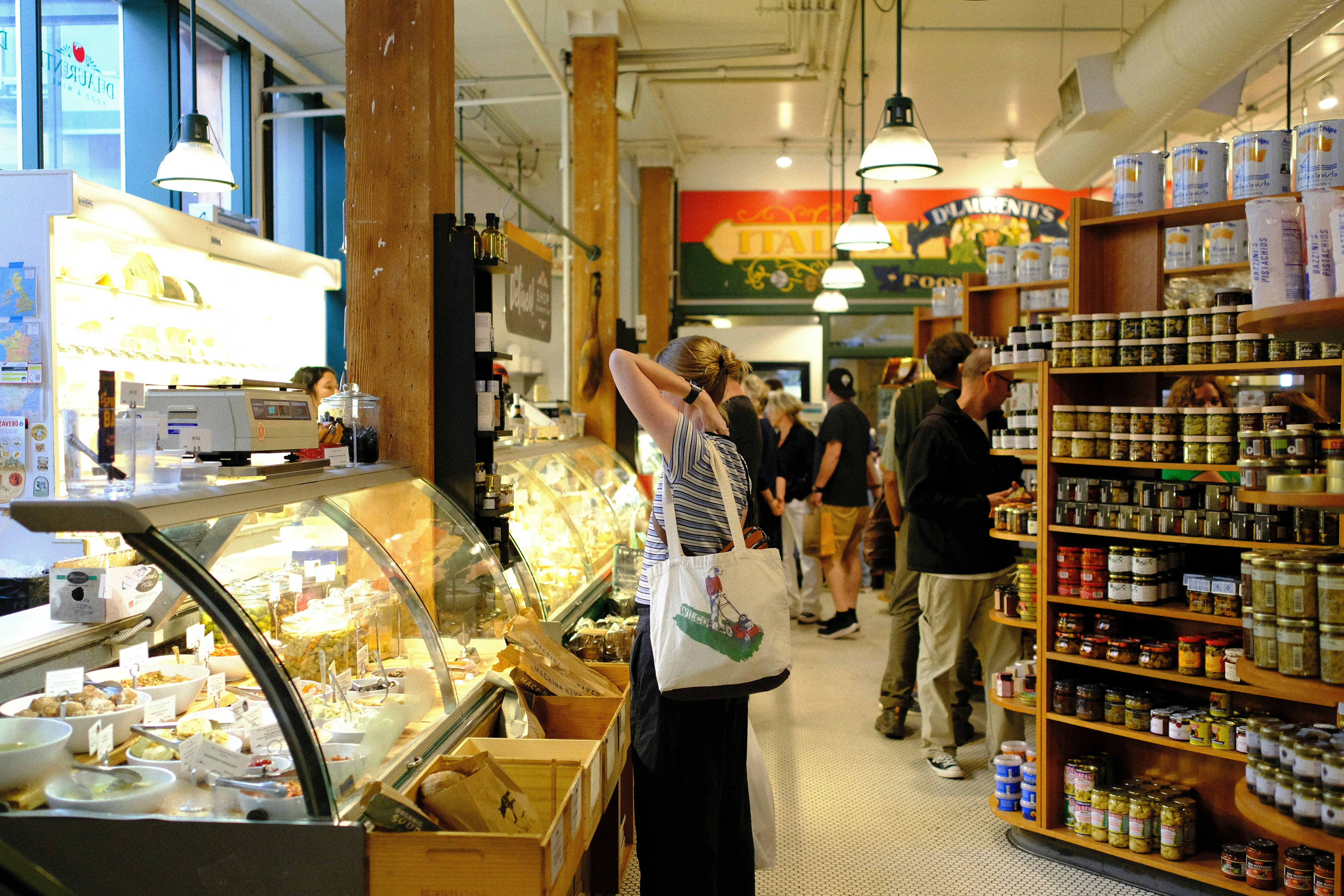 Aisle Reverie at the Deli Counter: Sunlit bustle in a neighborhood market
