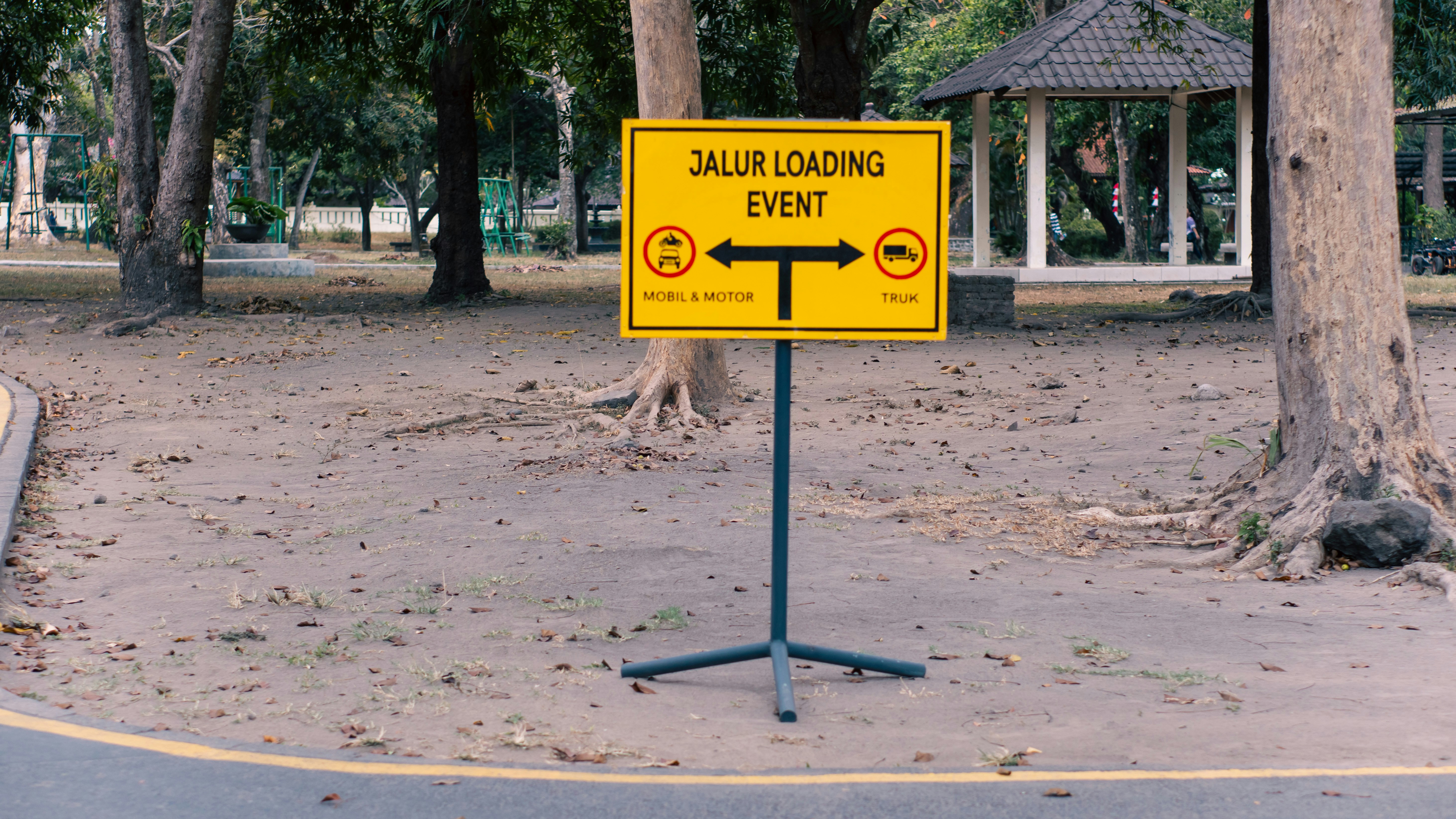 Yellow Parking Sign in a Quiet Park Corridor