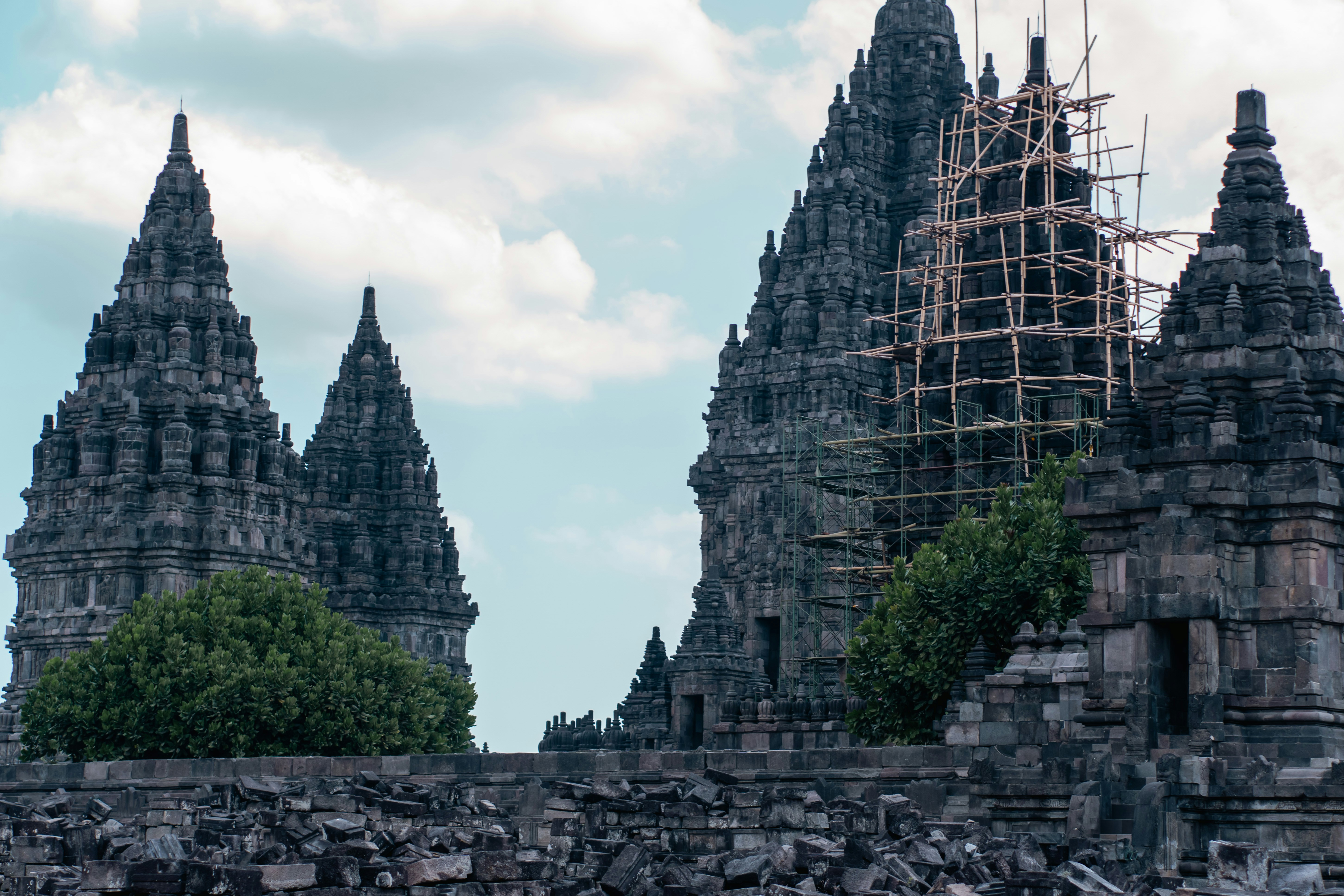 A group of stone structures with scaffolding around them photo – Free ...