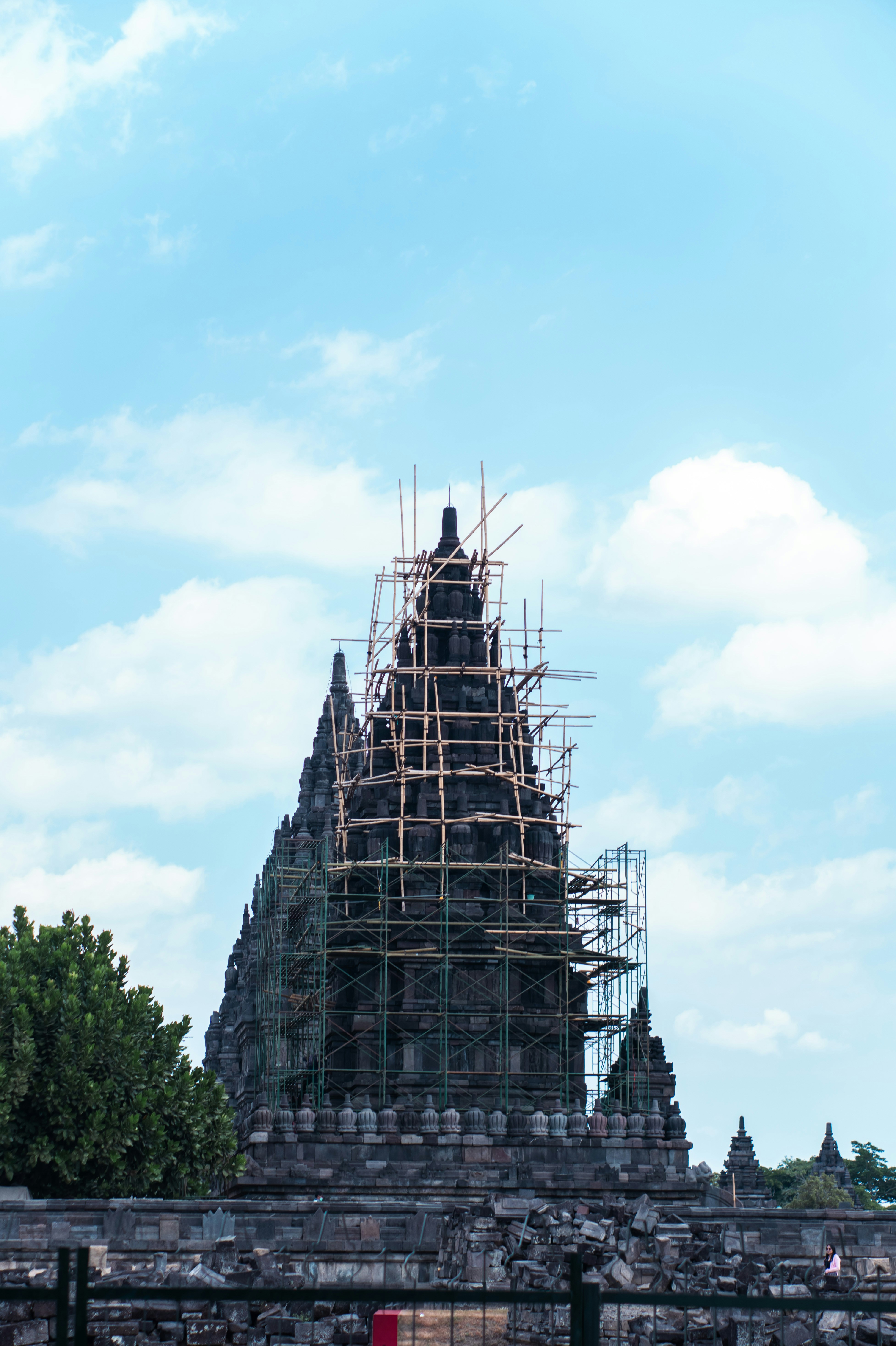 Bamboo-Laced Scaffolding Cloaks an Ancient Temple Tower Under a Cerulean Sky