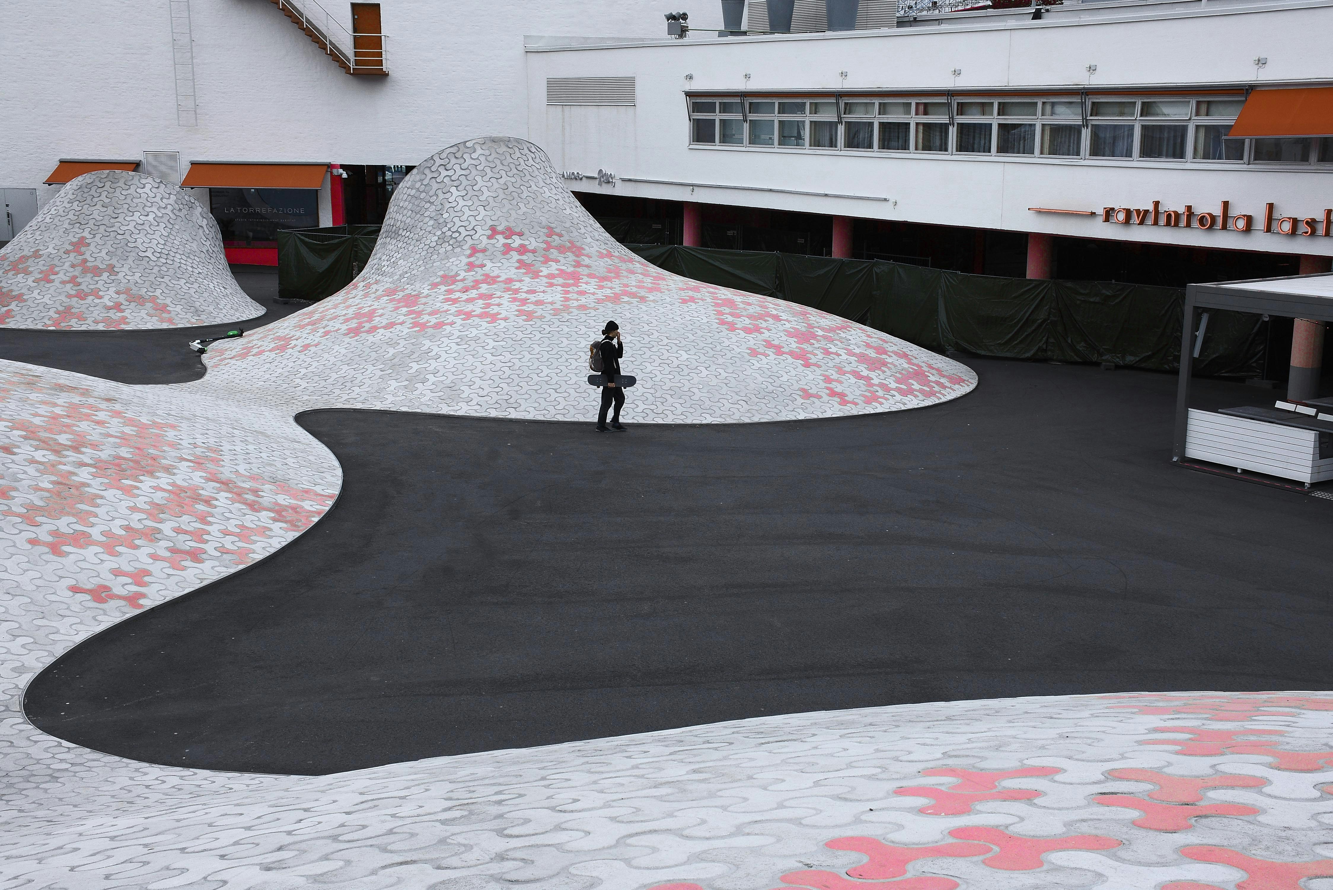  solitary figure amid curling skate plaza of monochrome waves 