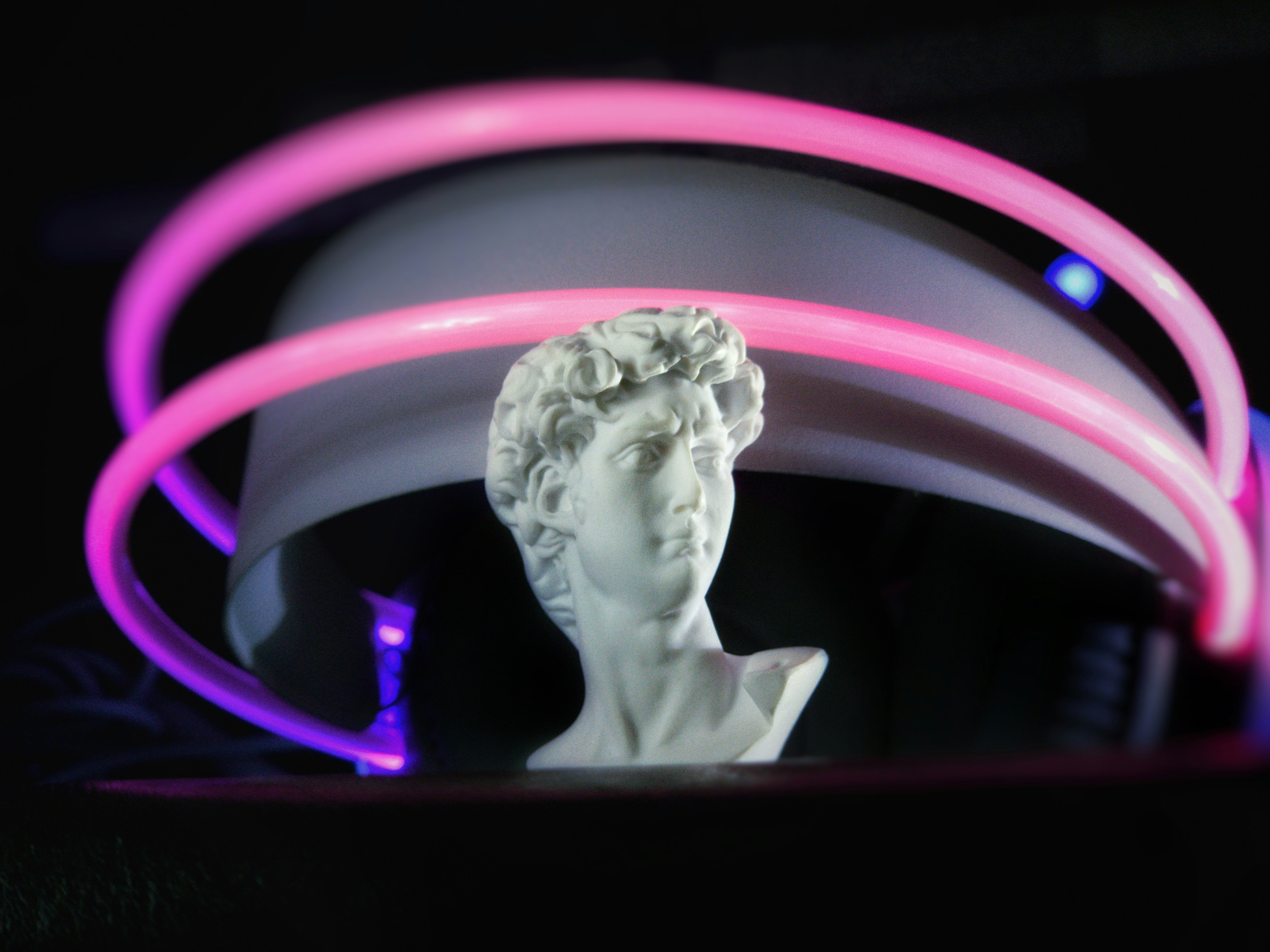 Neon Ringed Bust: Classical Head Framed by Glowing Orbits