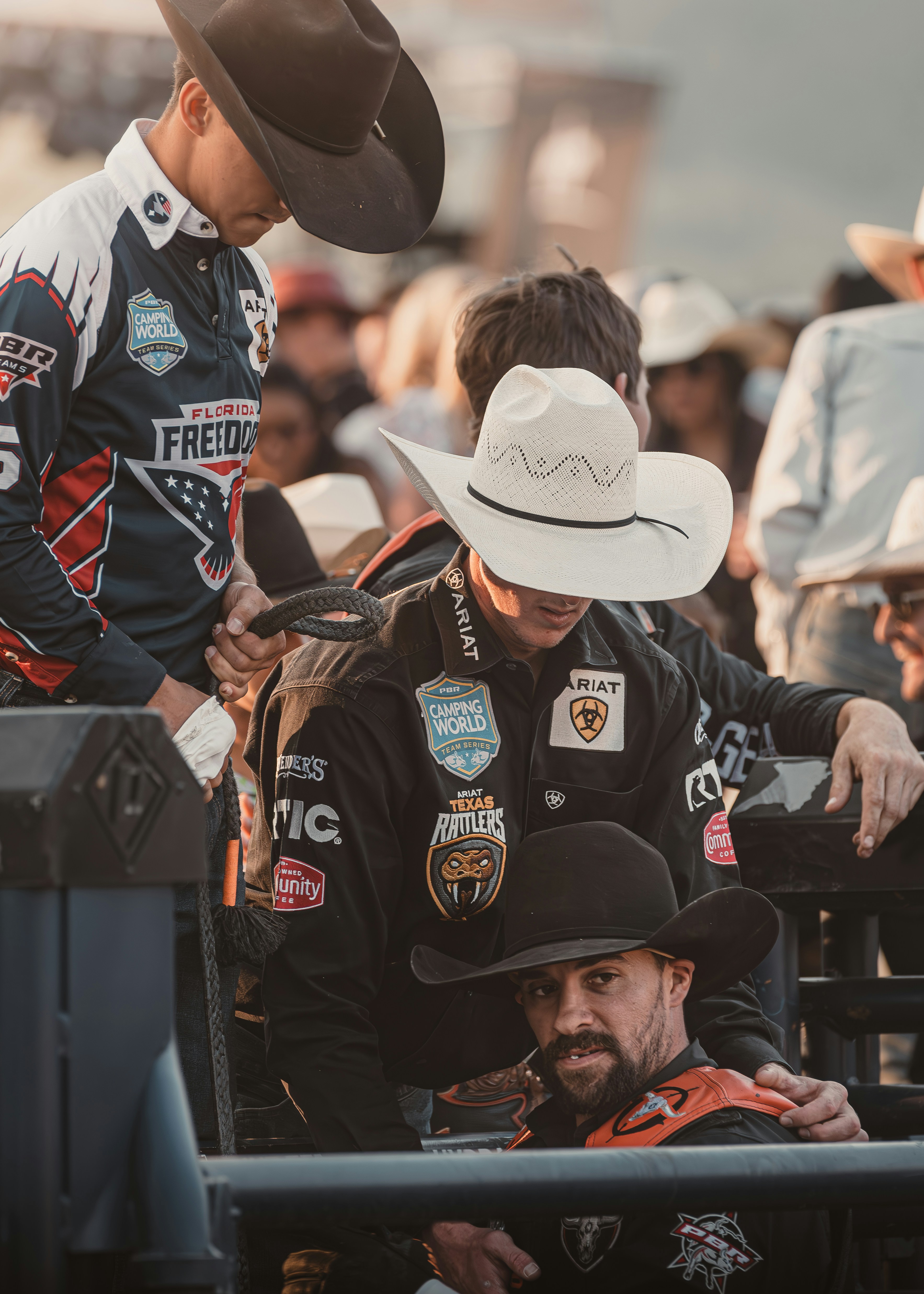 A group of men standing around each other wearing hats photo – Free Big ...