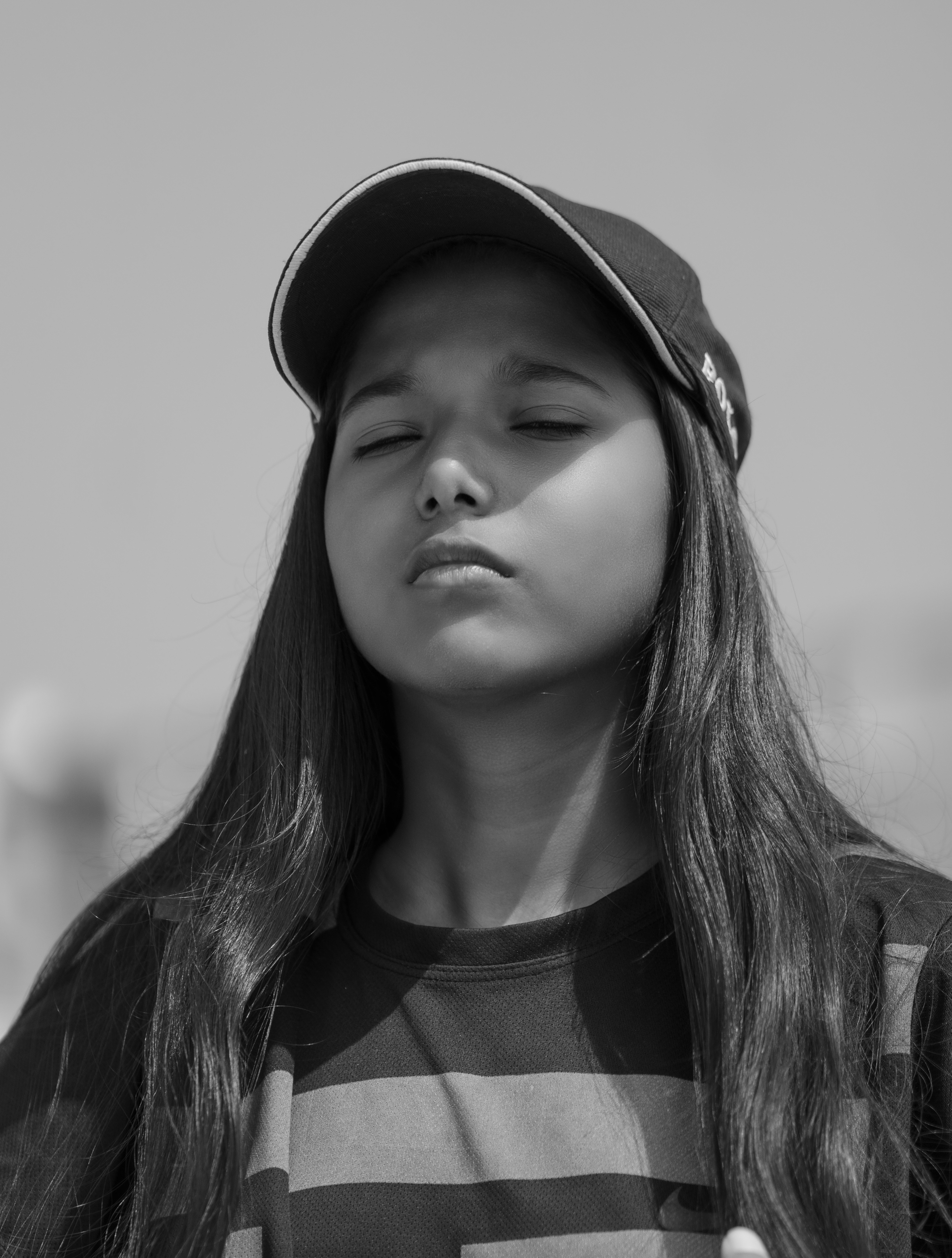 A young girl with long hair wearing a baseball cap photo – Free Waah ...