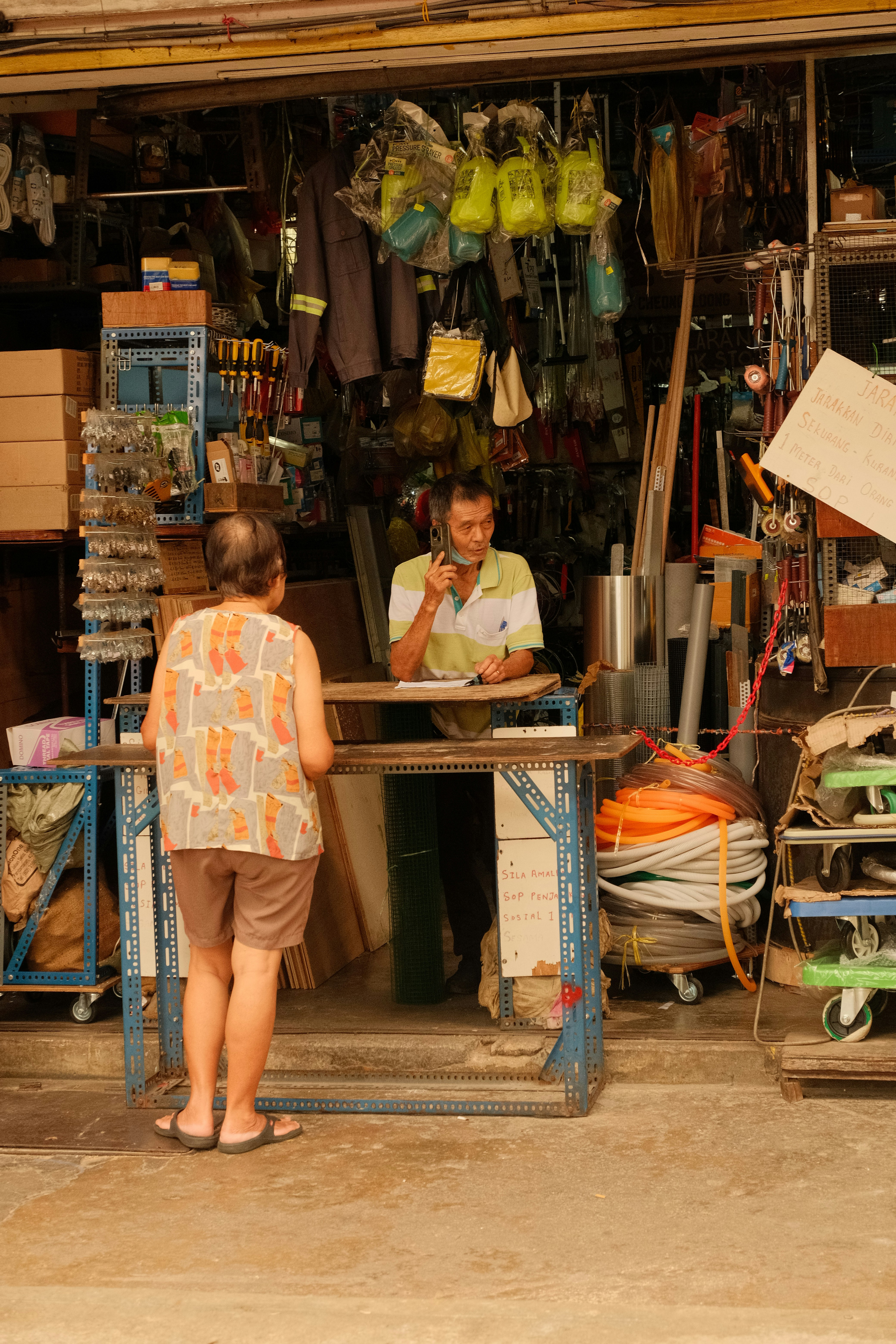 A man and a woman standing in front of a store