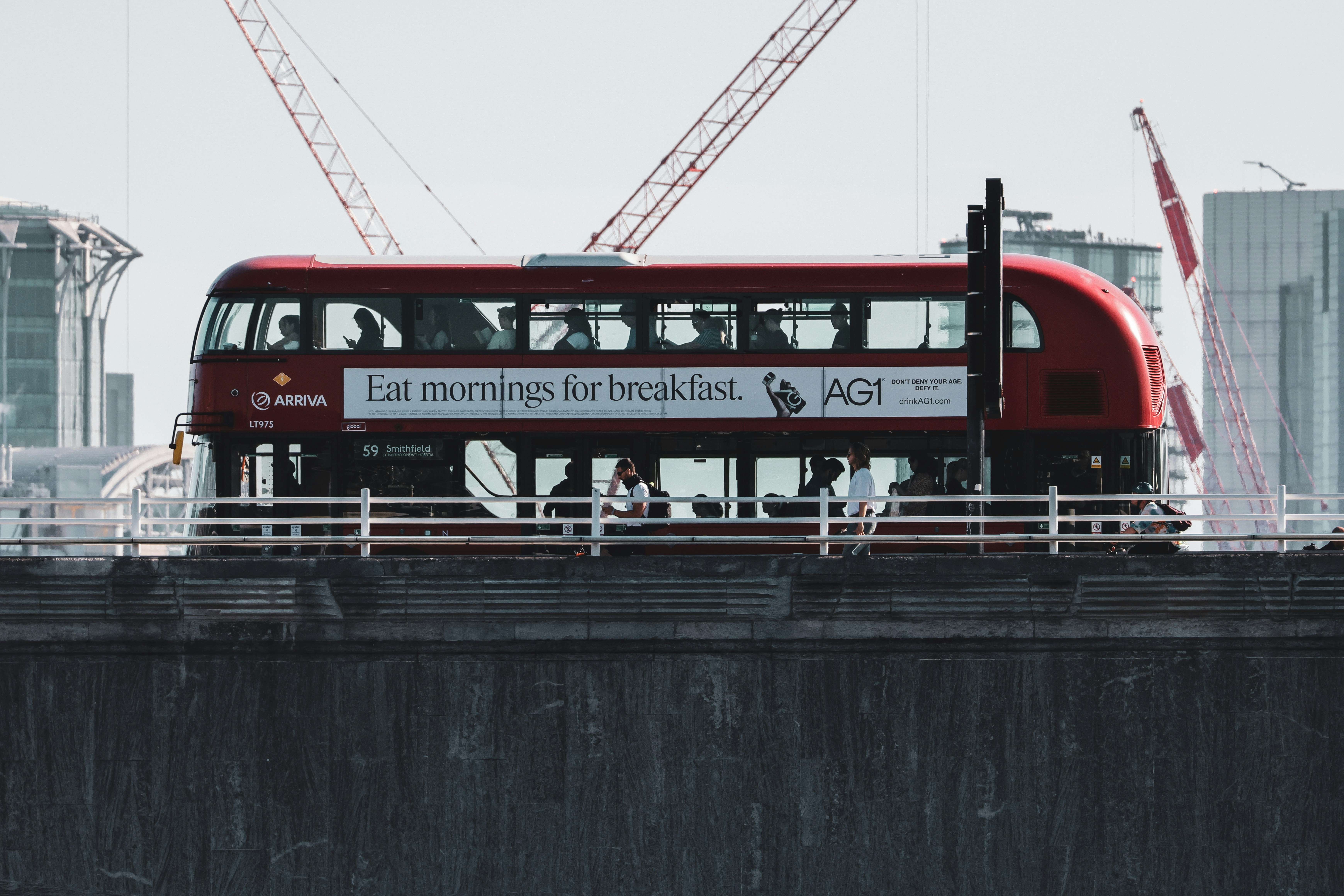 A red double decker bus driving over a bridge photo – Free London Image ...