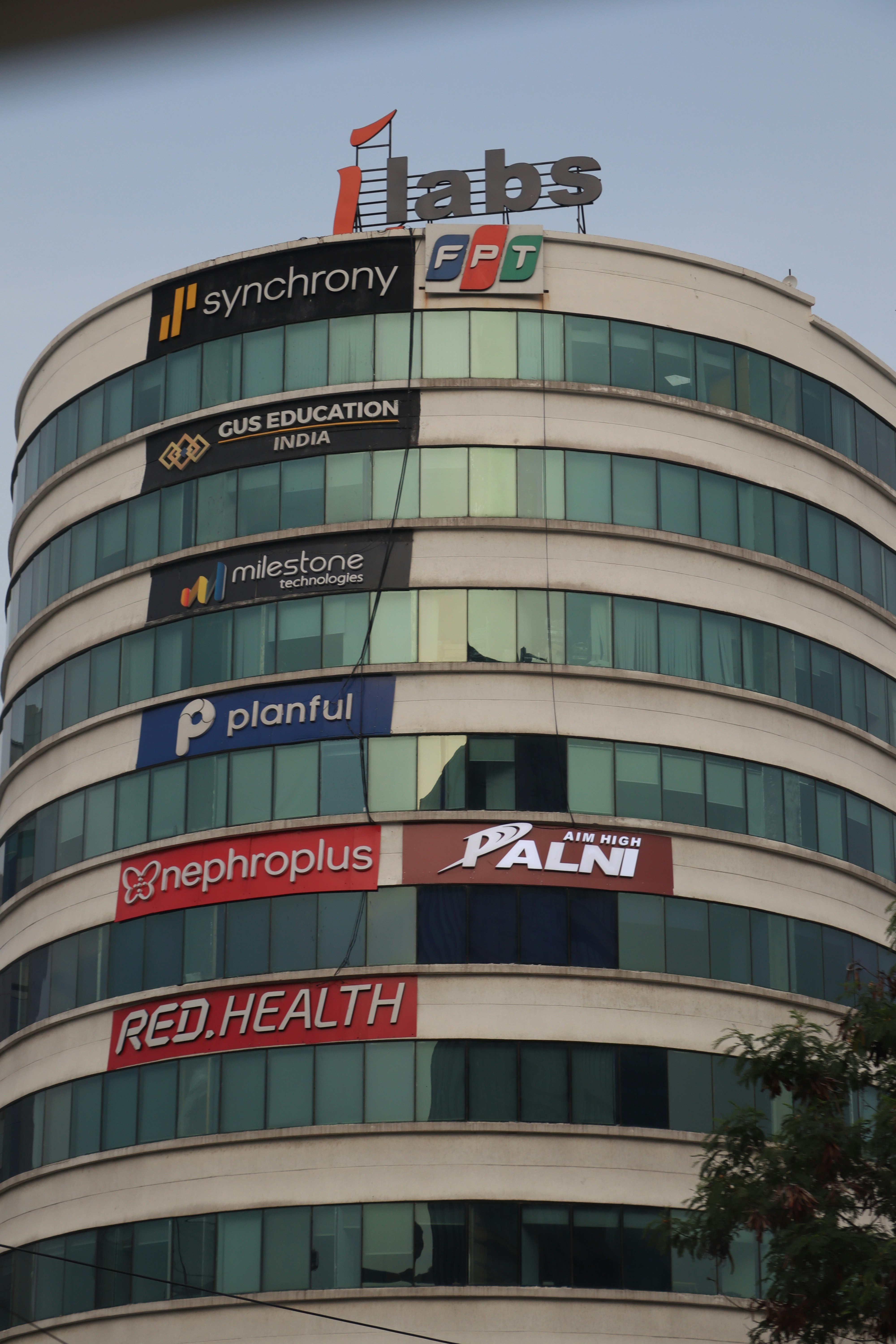 Branding Rings: A Curved Office Tower Adorned with a Palette of Logos