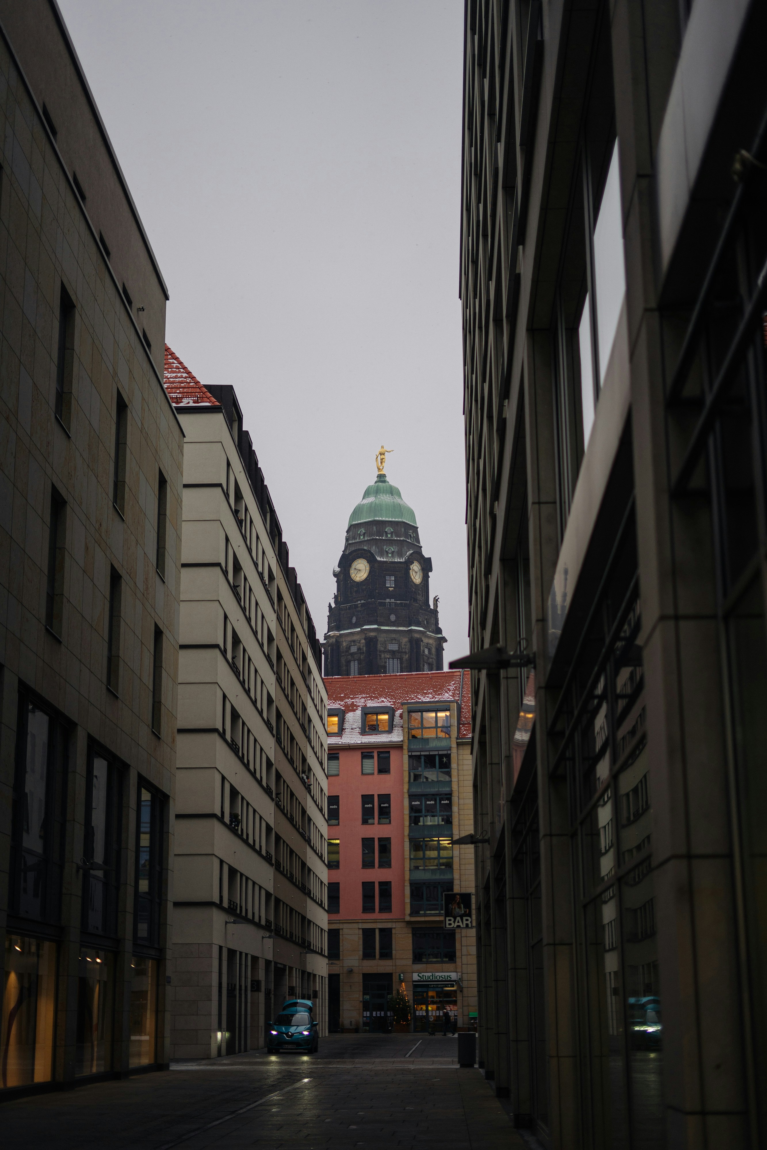 Green-Crowned Clocktower at the End of a Narrow Urban Canyon