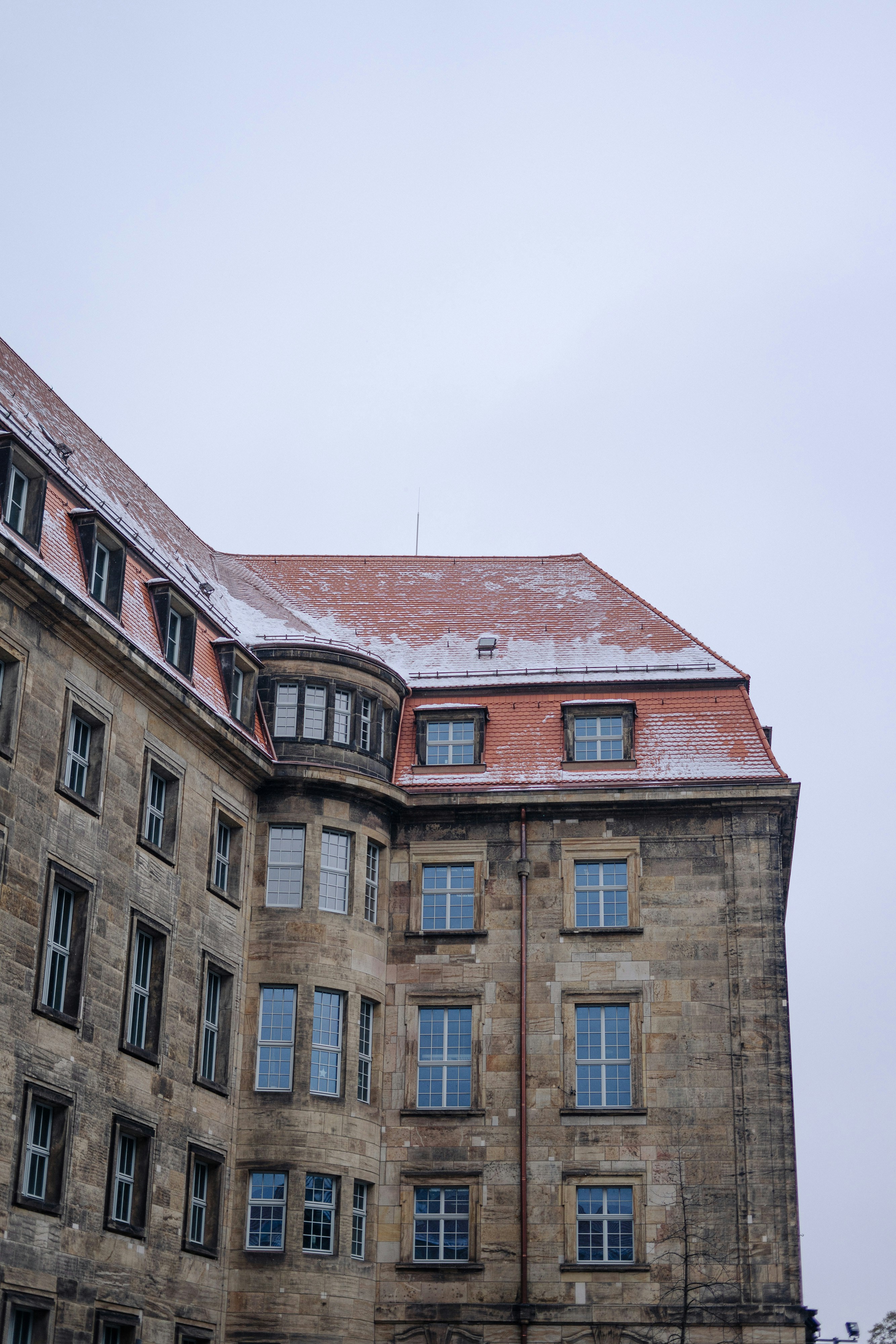 Snow-Kissed Turret Framing a City Brick Facade