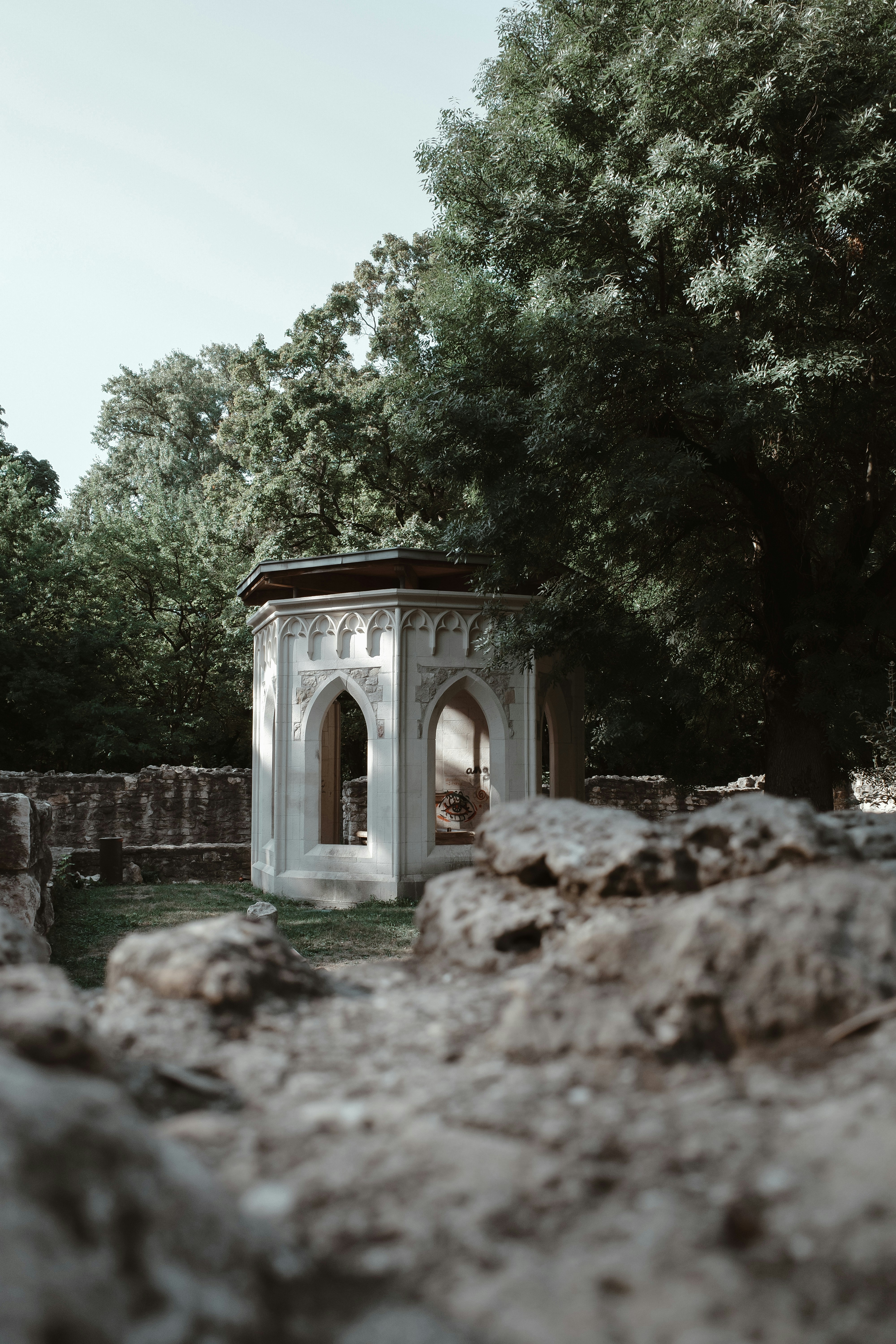 Whispered Arches: A White Pavilion Amid Timeless Ruins