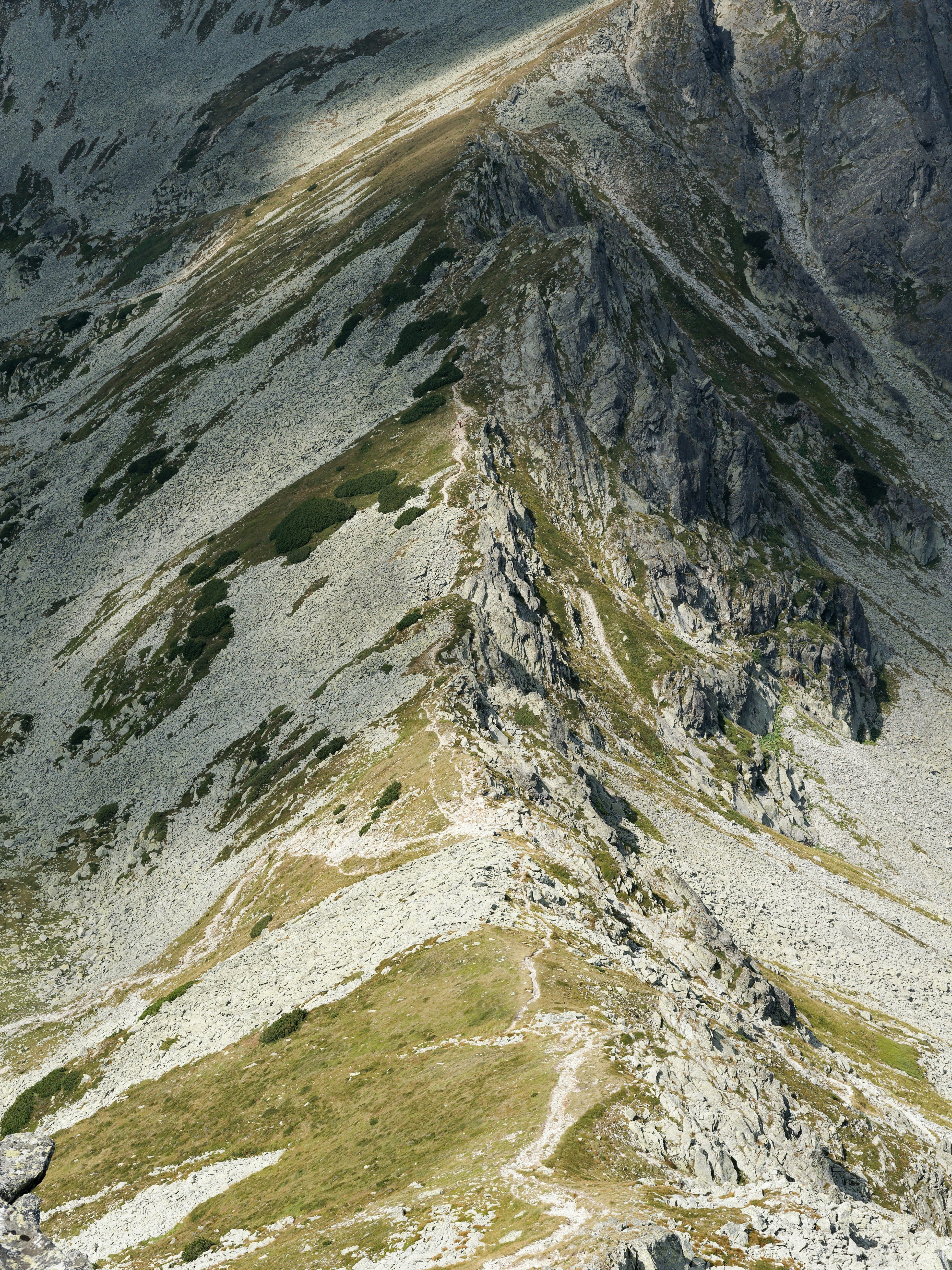 A very tall mountain with a very steep side photo – Free Retezat ...