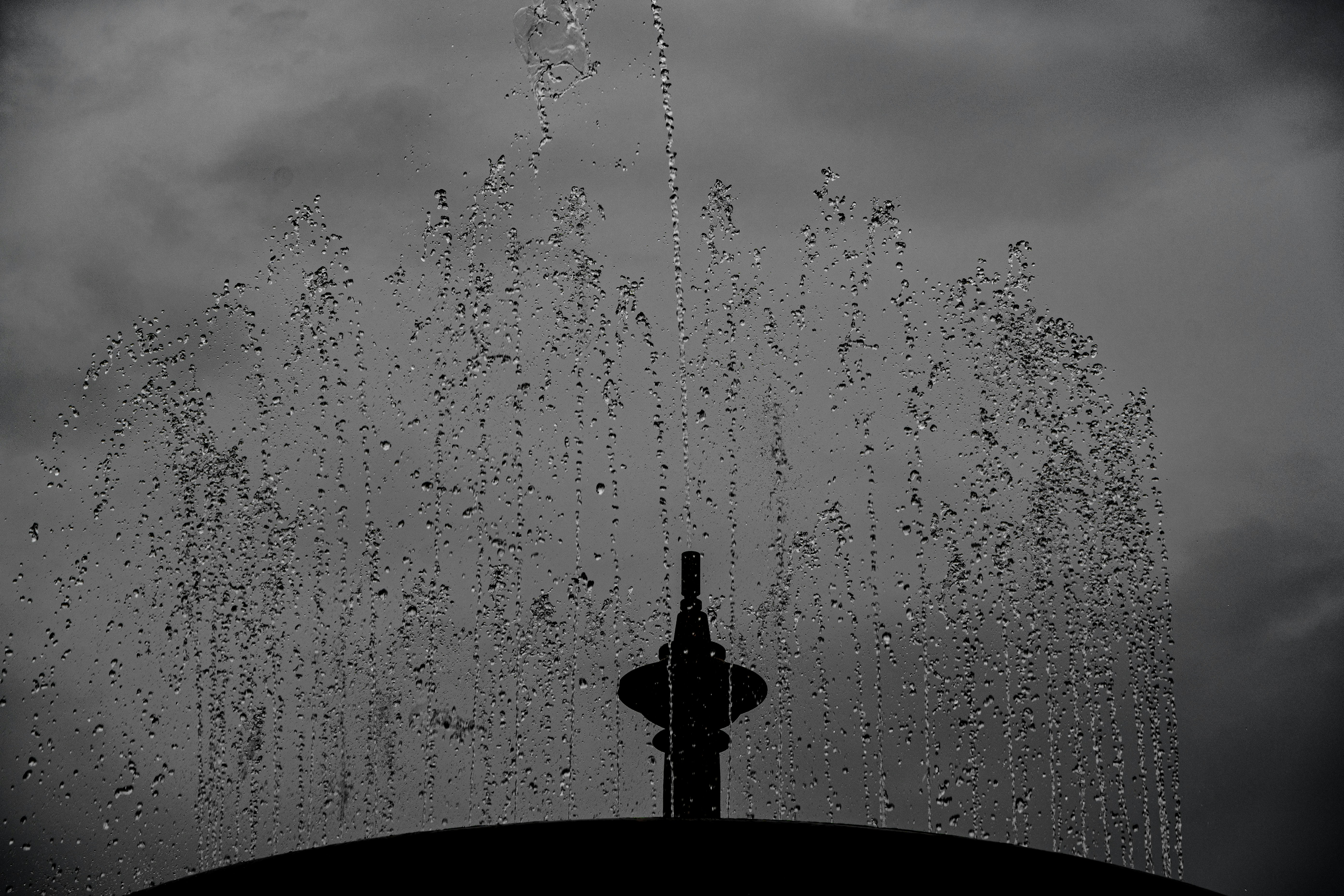 Silhouette of a Water Cascade Crowned by a Central Structure