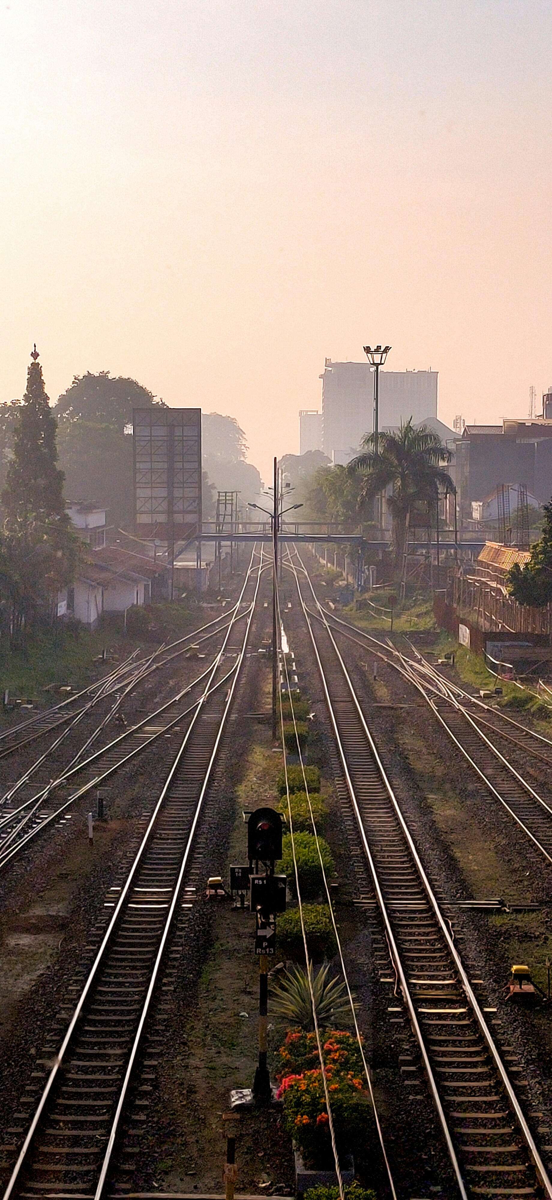 A view of a train track with buildings in the background photo – Free ...