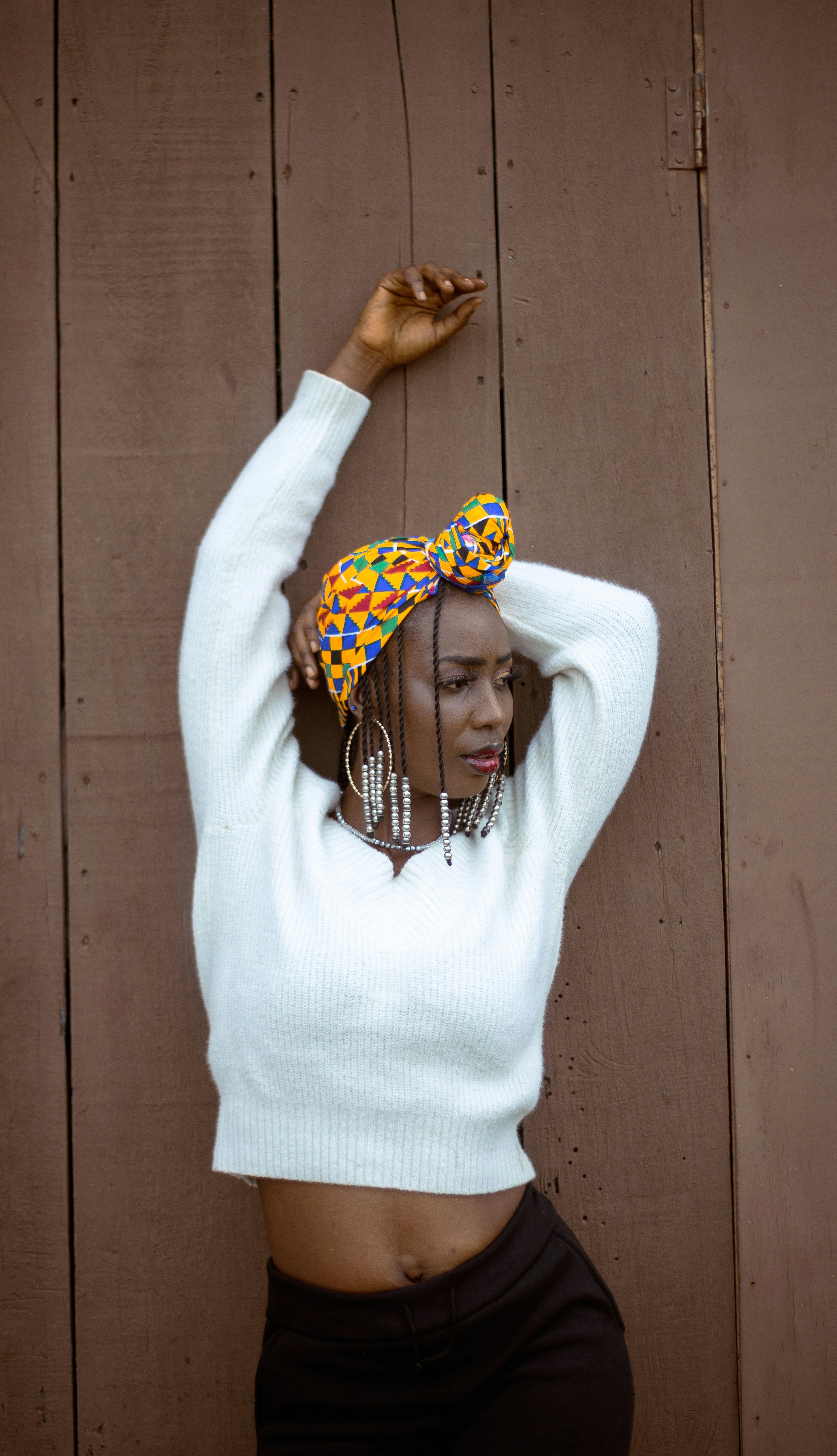 A woman wearing a white top and a colorful head scarf photo – Free ...