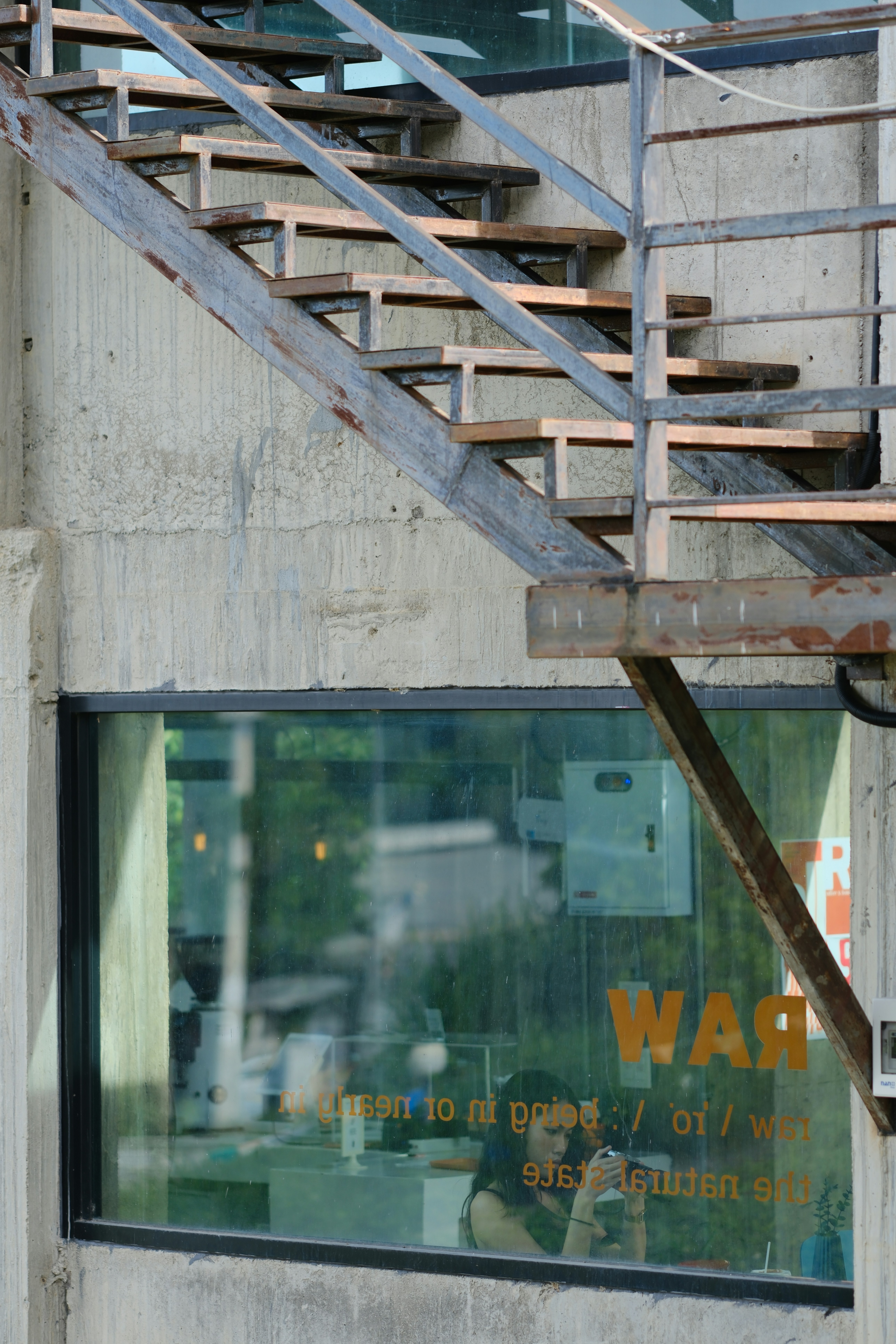Diagonal Steel Staircase Framing a Weathered Concrete Facade