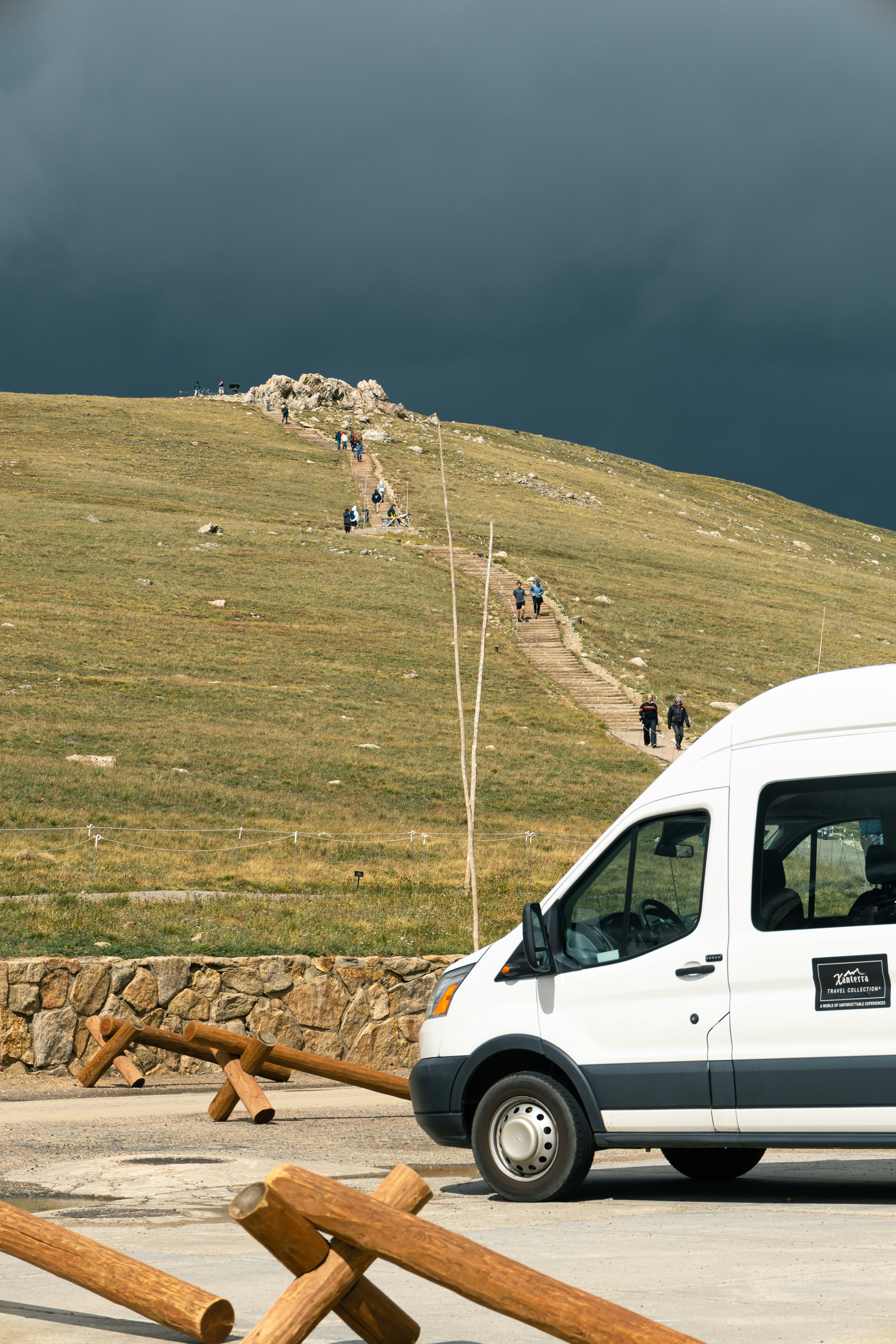 Hikers on the Crest Amid a Looming Storm