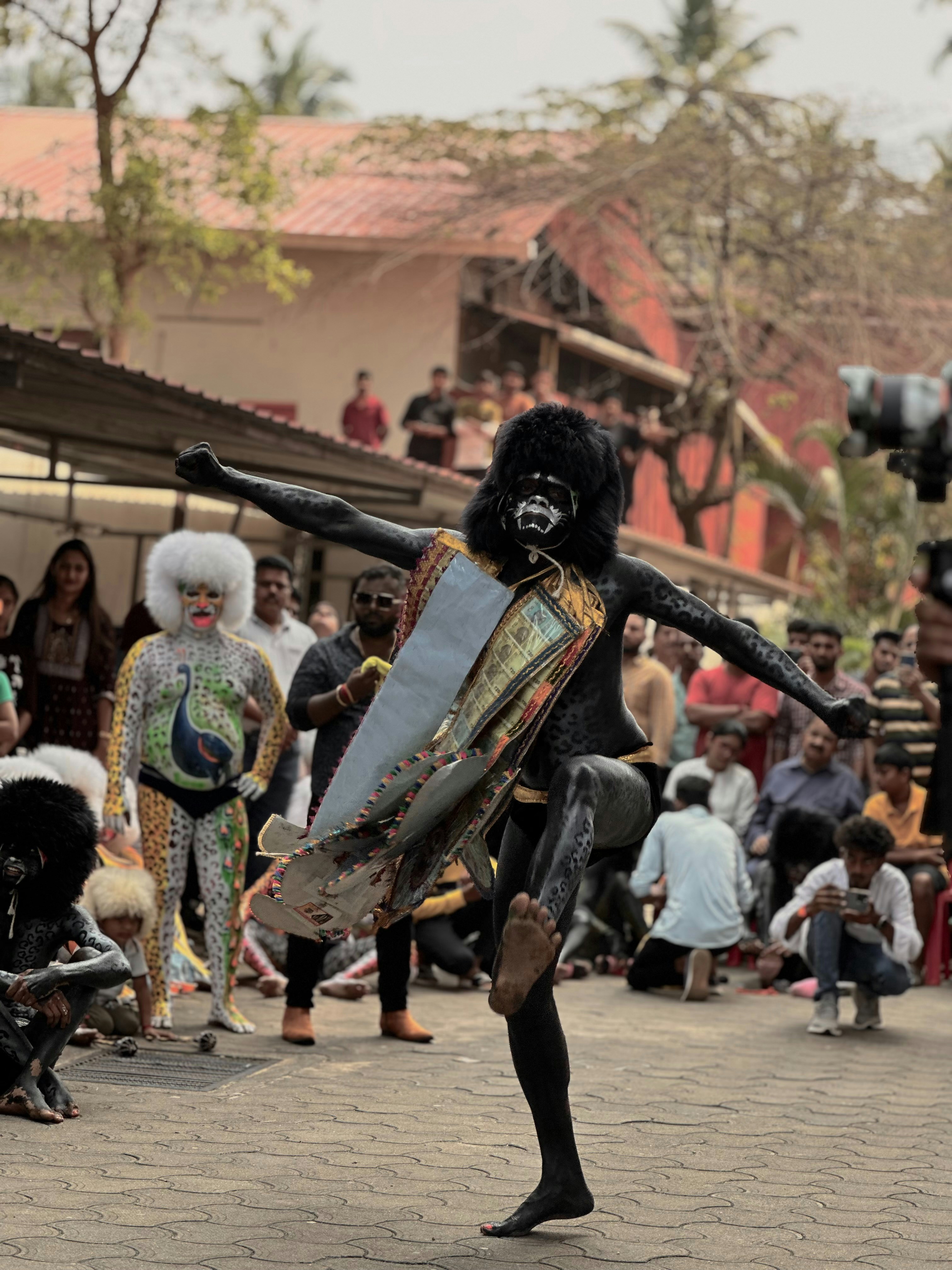 A man dressed in a costume is dancing on a street photo – Free Woman ...