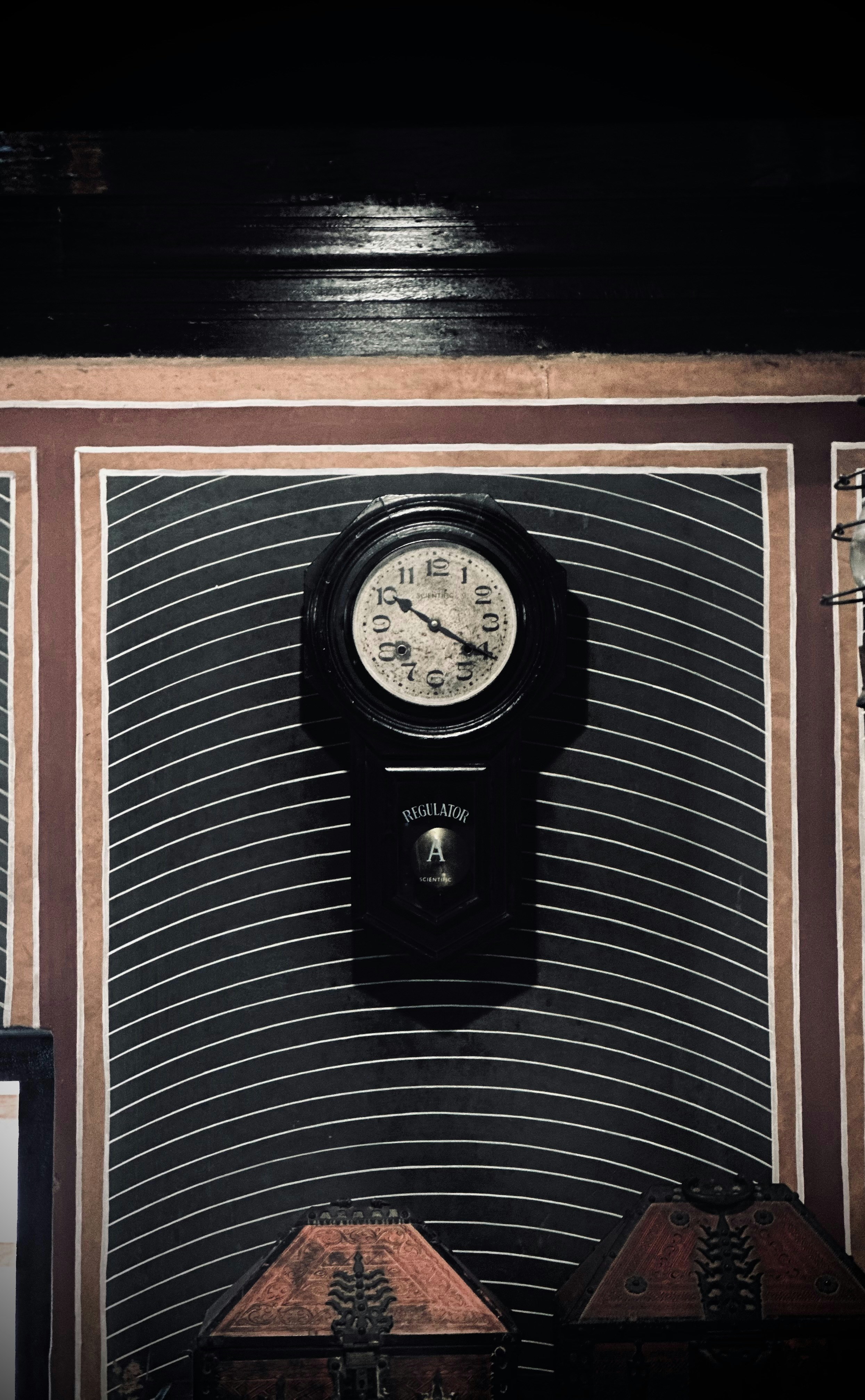 Timekeeper Centered on Concentric Waves in a Dim Vintage Hall