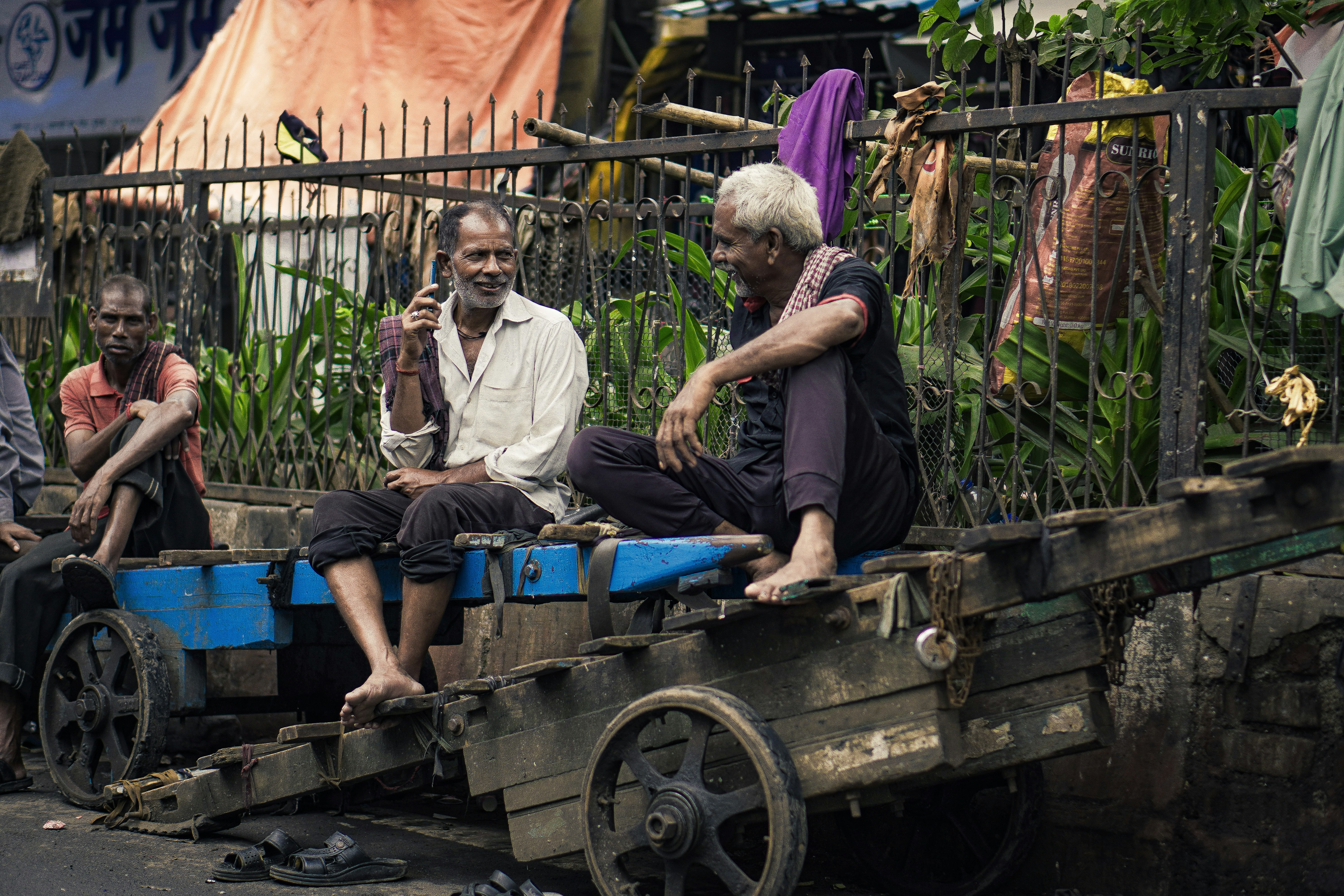A group of people riding on the back of a truck photo – Free Adult ...