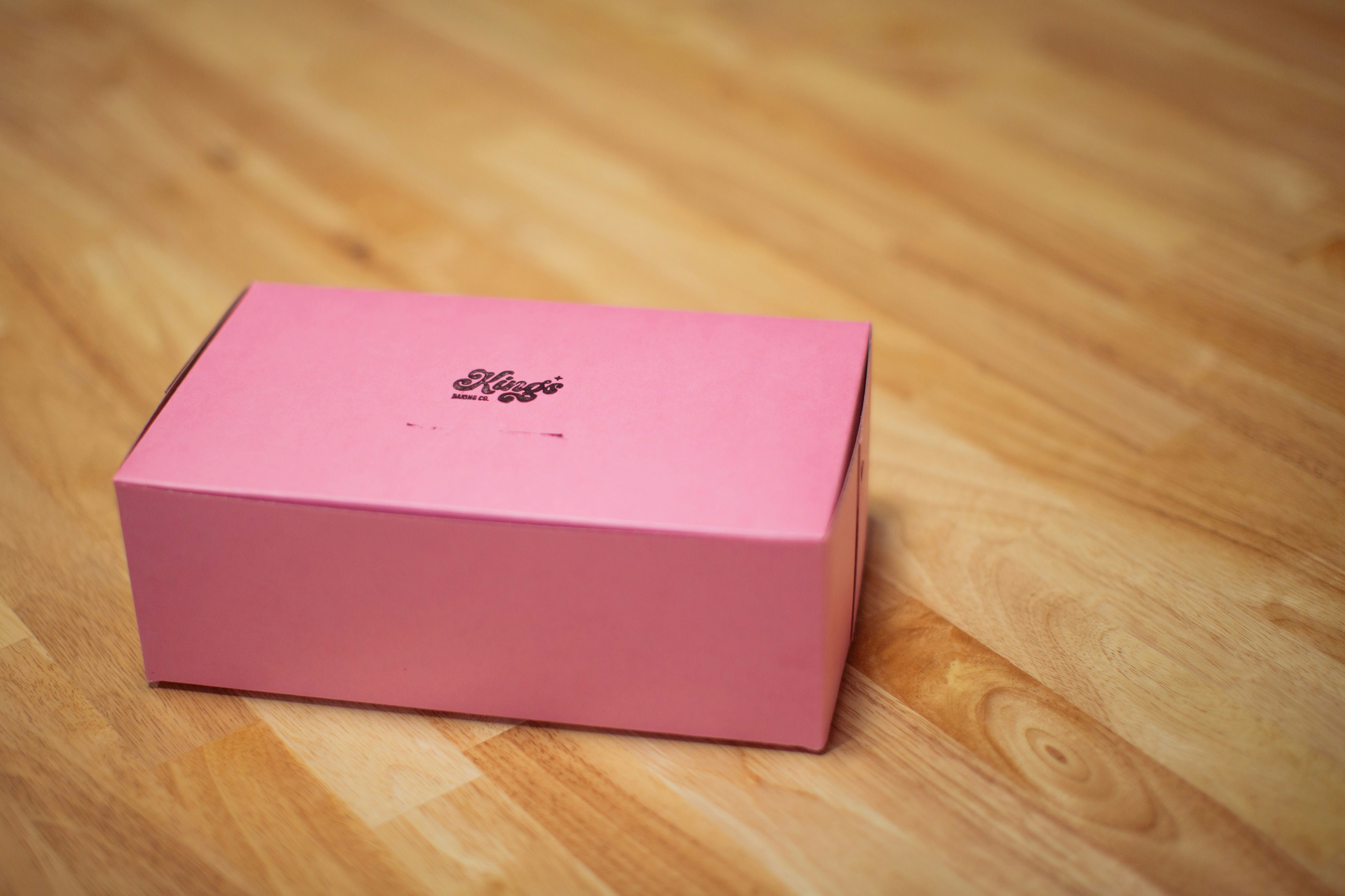A pink box sitting on top of a wooden floor photo – Free Box Image on ...