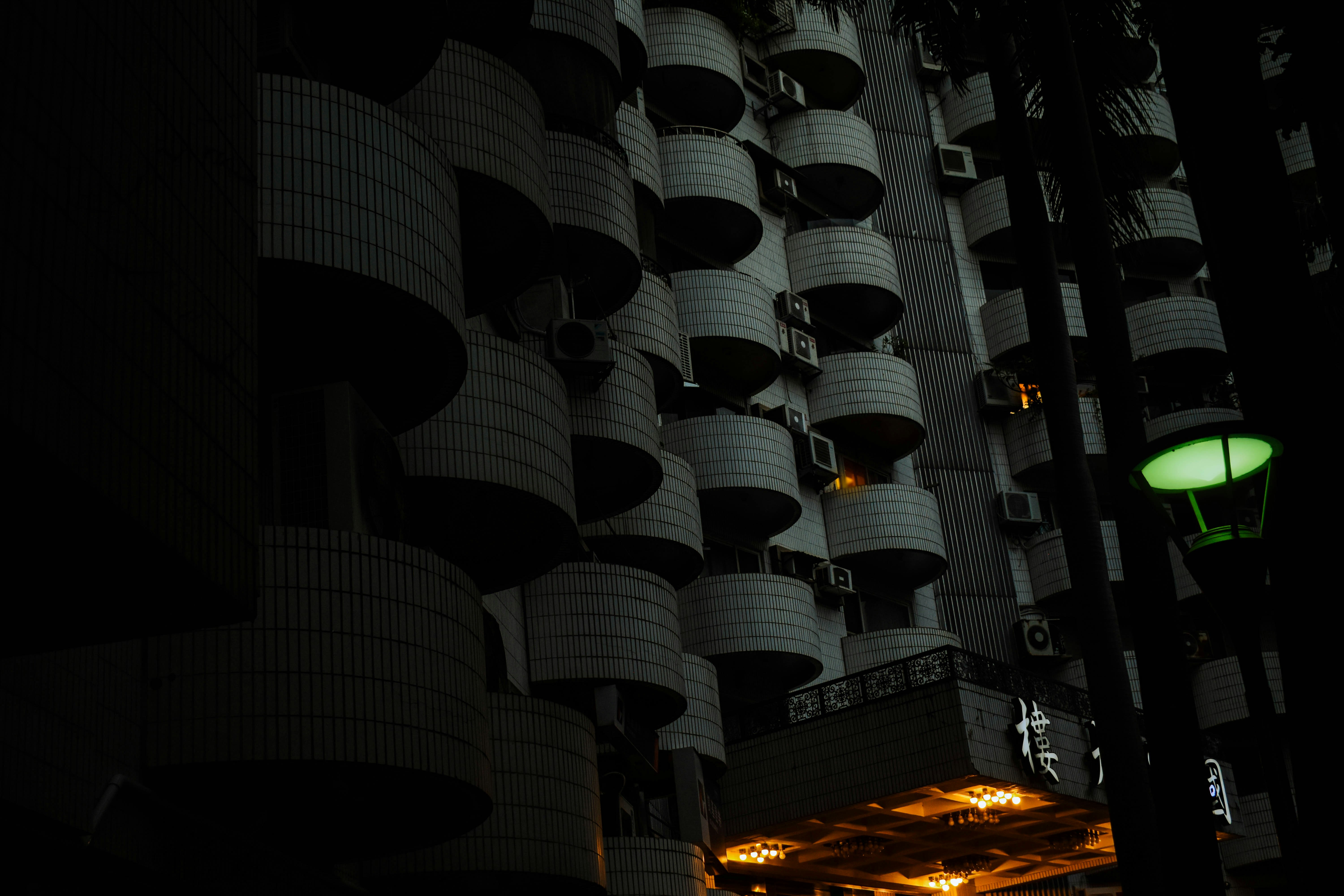 A green street light in front of a tall building photo – Free Building ...