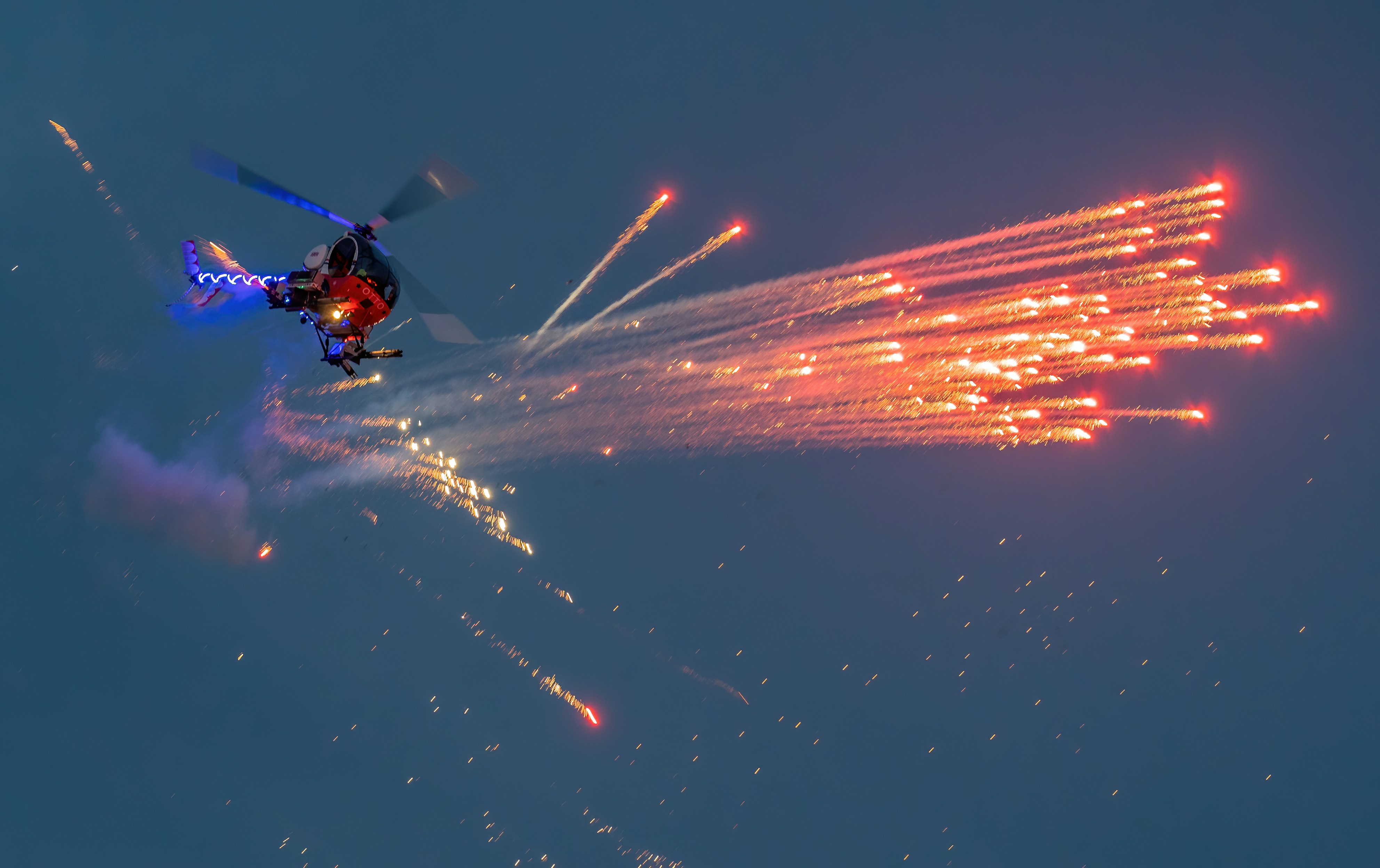 Helicopter Firefall: A Spear of Sparks Across a Velvet Sky