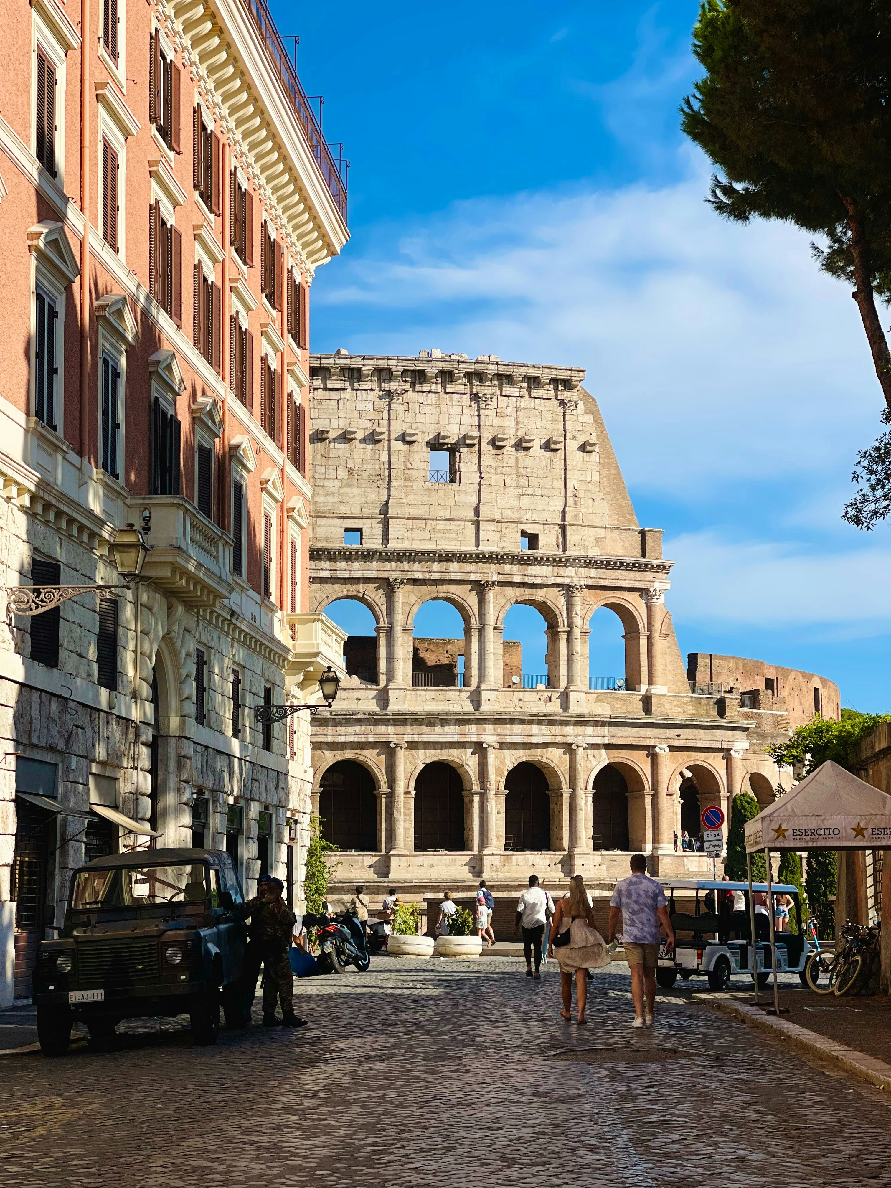 Arches and Avenue: Rome's Colosseum Framed by a Sunlit Street