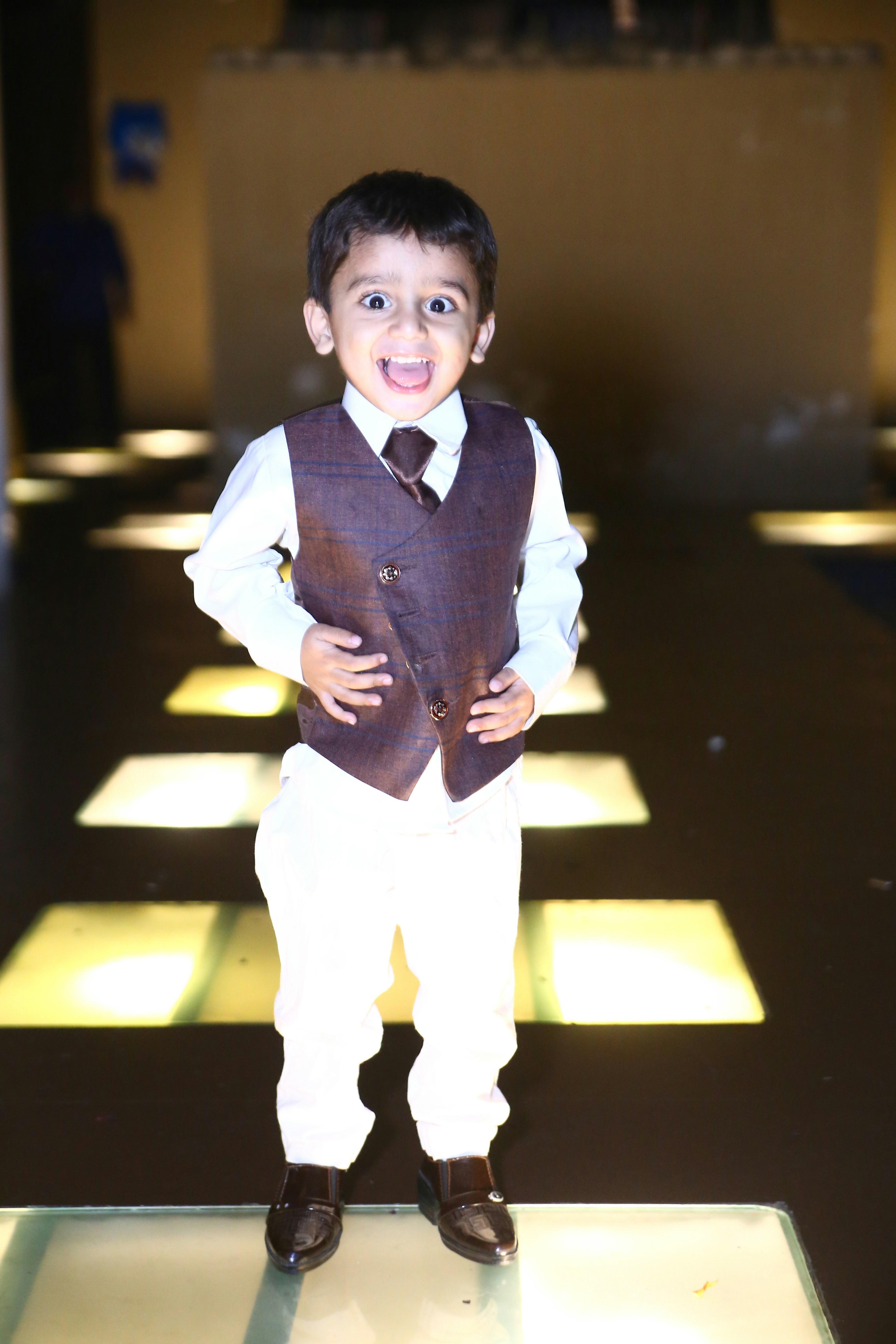 Tiny Gentleman, Big Cheer: A Whimsical Moment on Glowing Tiles
