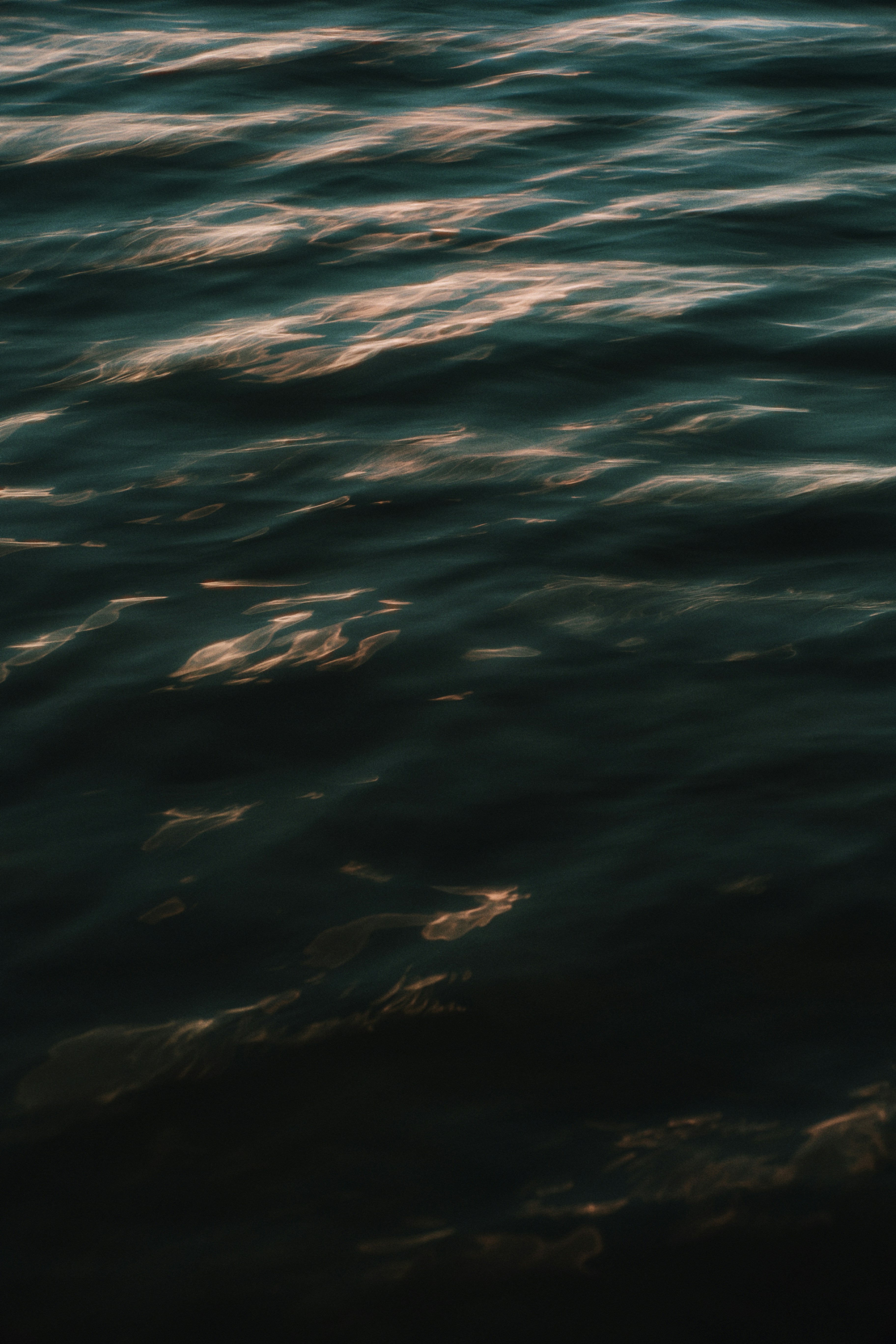 A body of water with a boat in the distance photo – Free Texture Image ...