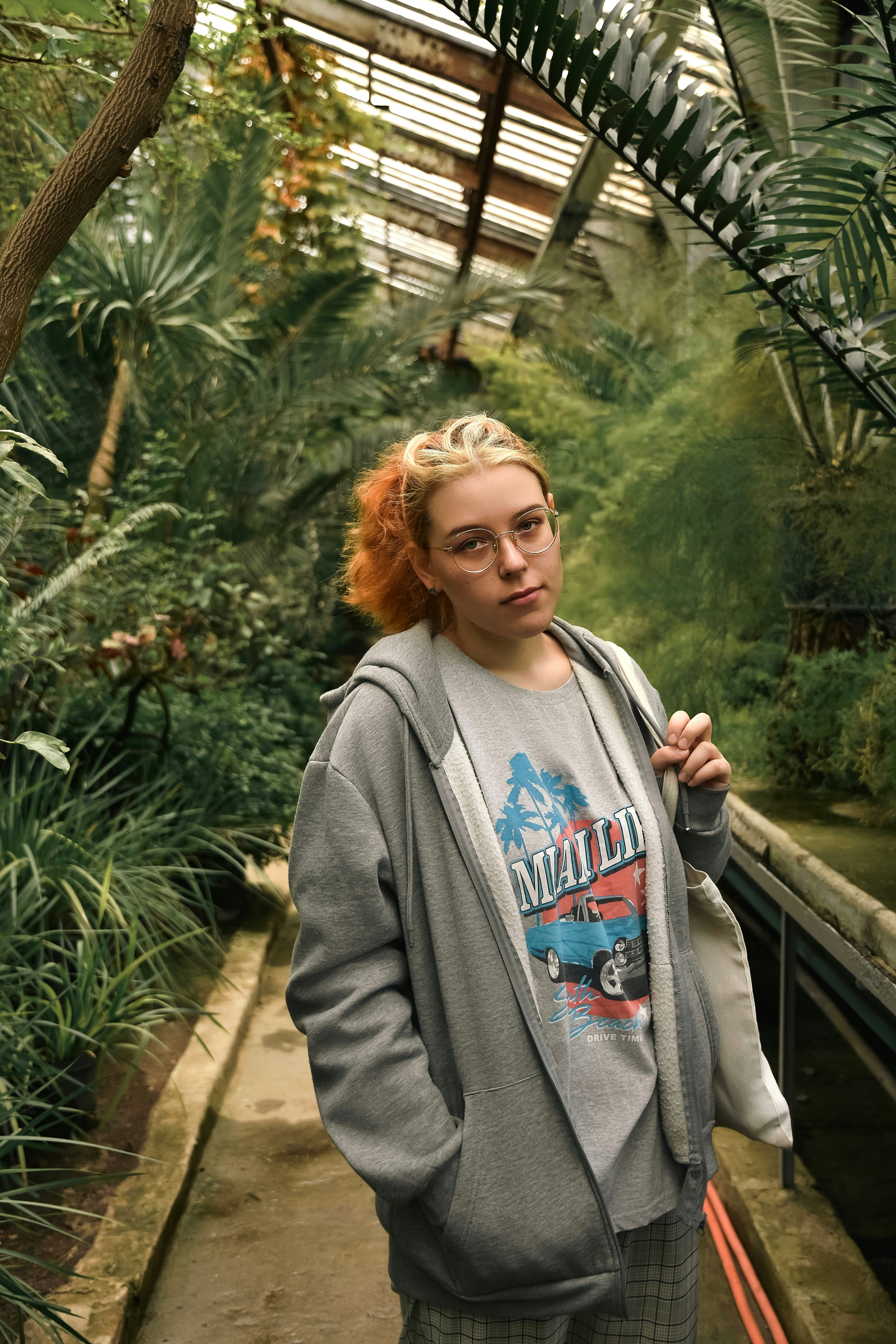 Glasshouse Portrait: Quiet Confidence Among Tropical Foliage