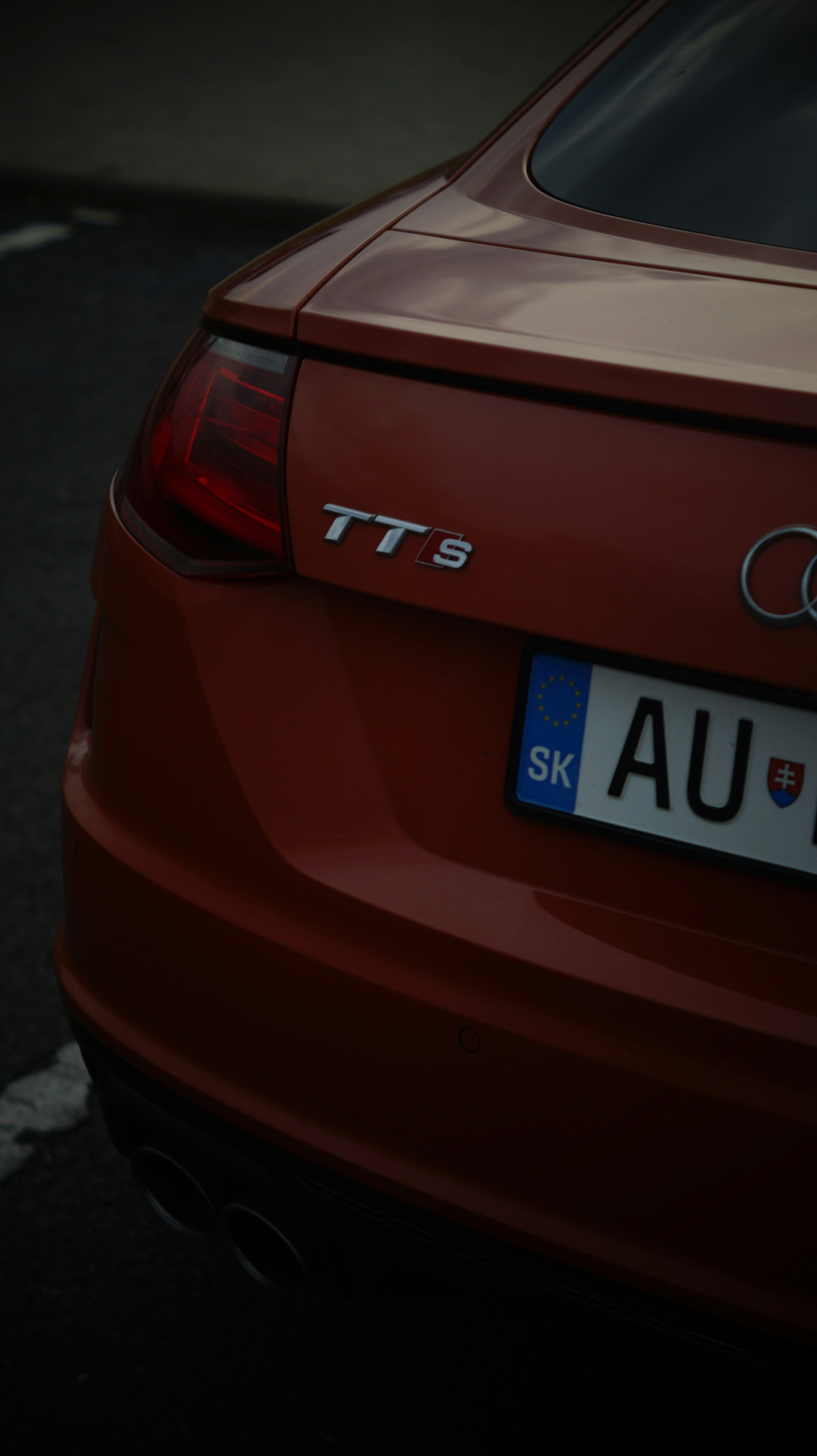 Rear Portrait of an Orange Audi TTS in Quiet Dusk