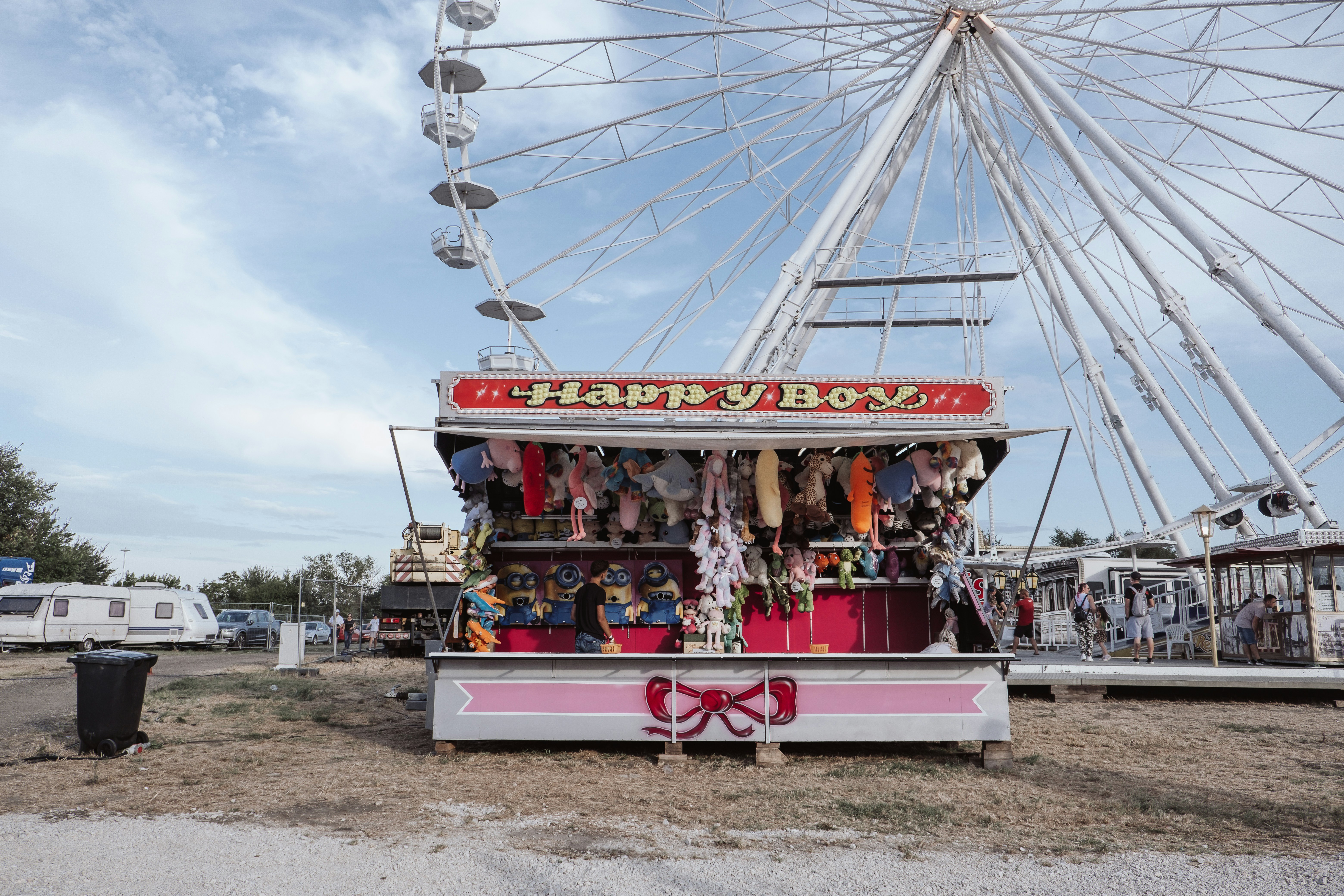 Carnival Booth at Dawn: Colorful Sweet Stand by the Giant Ferris Wheel