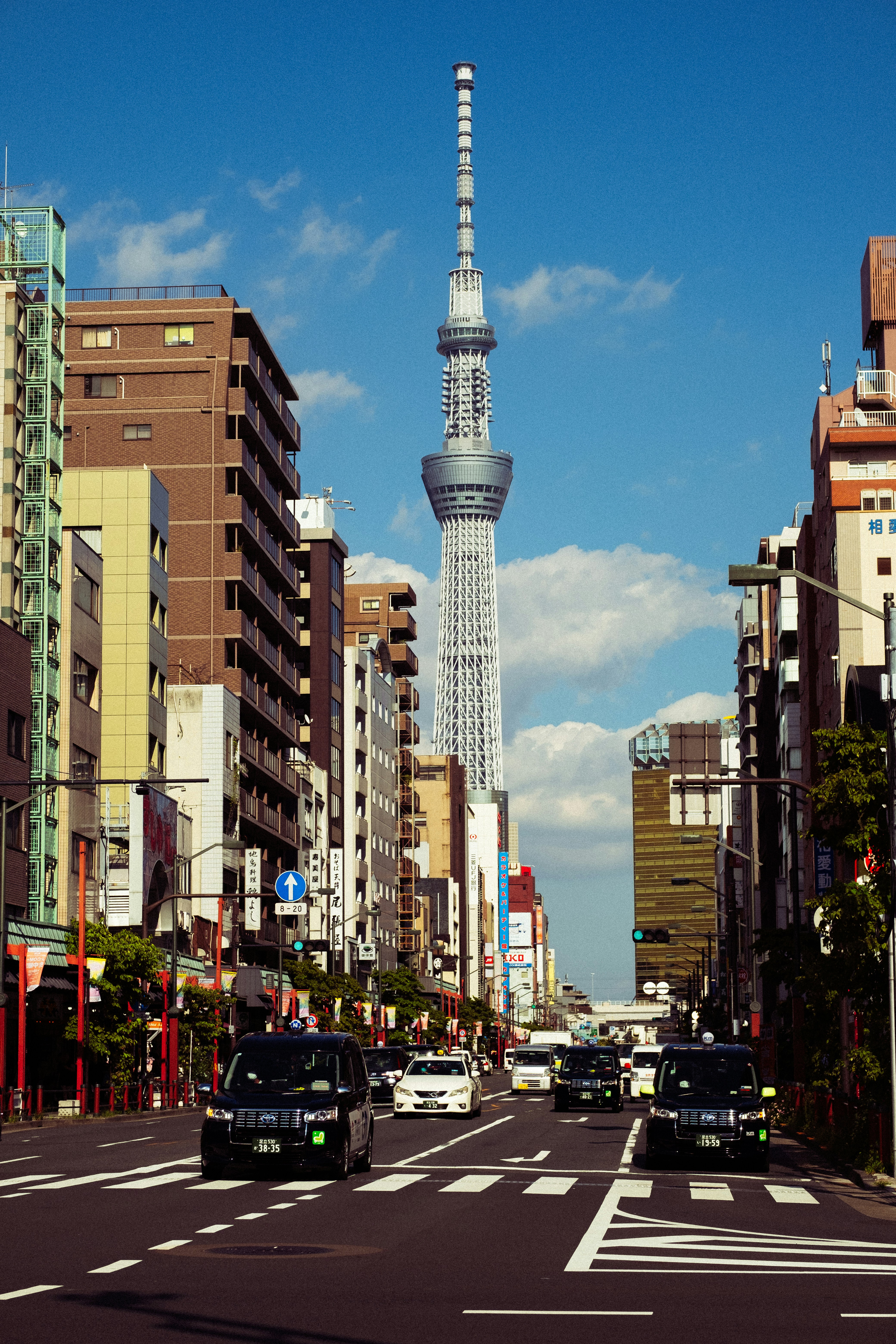 A city street with cars and tall buildings