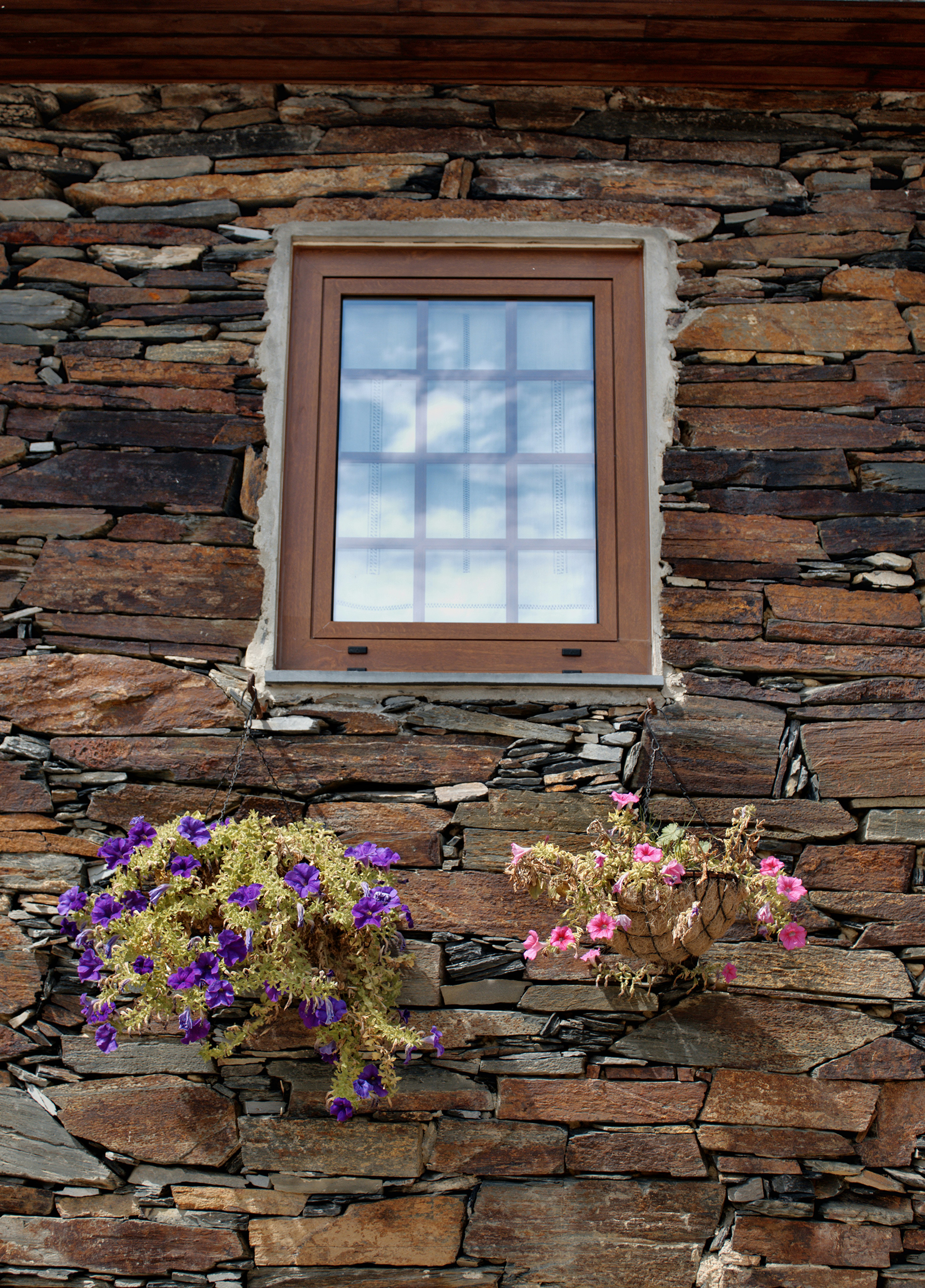 A stone wall with flowers and a window photo – Free Flower Image on ...