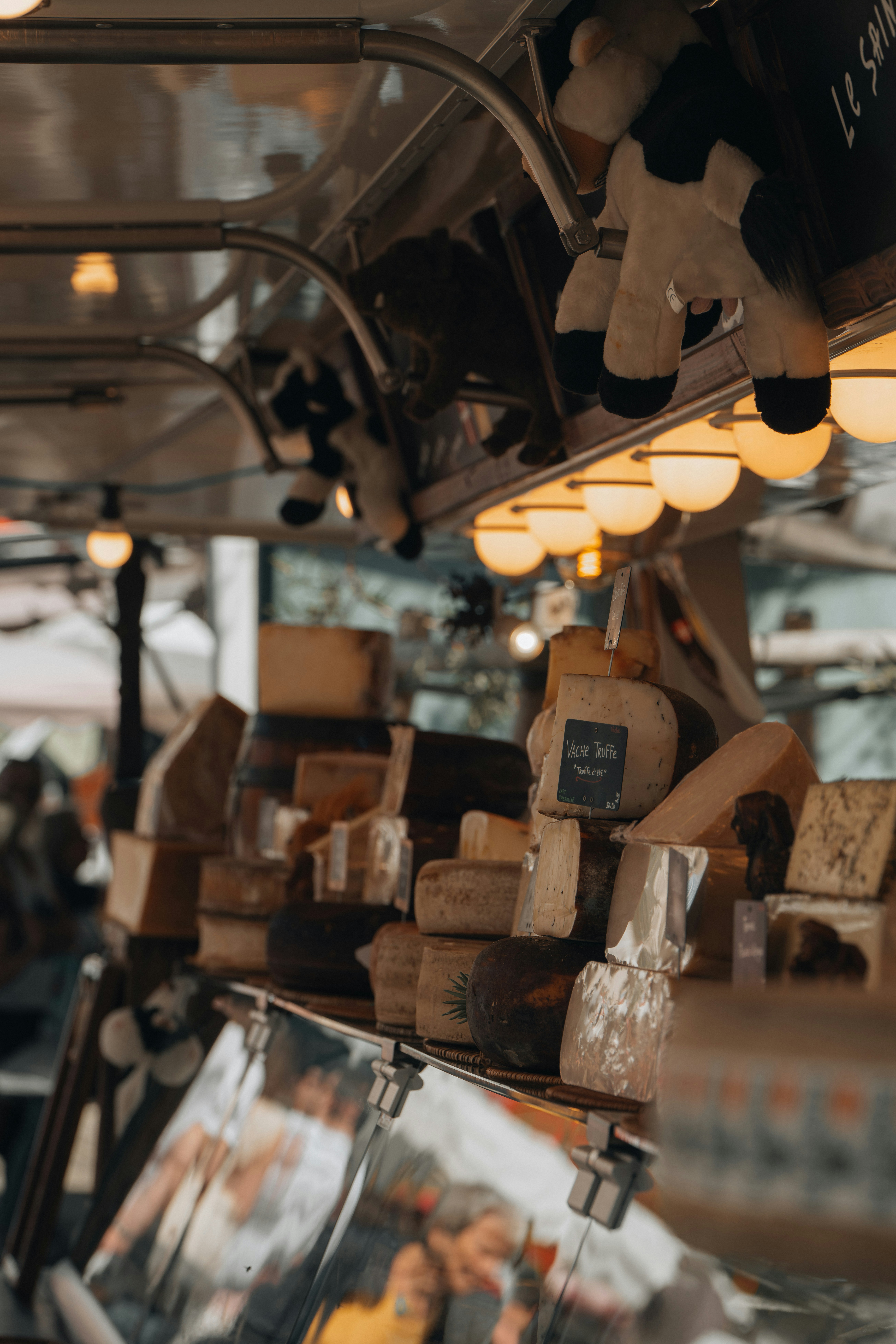 Amber Aisles: Handcrafted Cheese Blocks Beneath Vintage Market Lamps